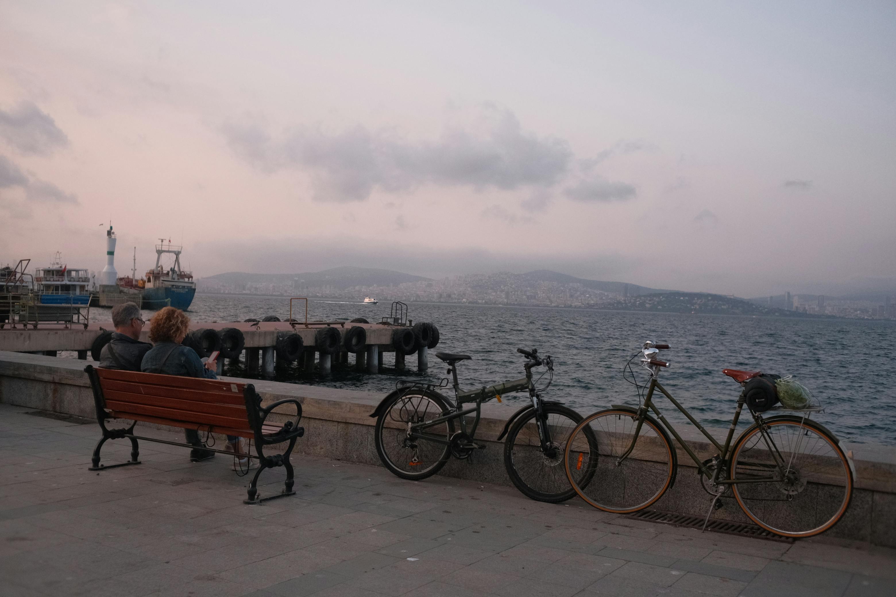 Man with Bike Sitting on Bench at Park · Free Stock Photo