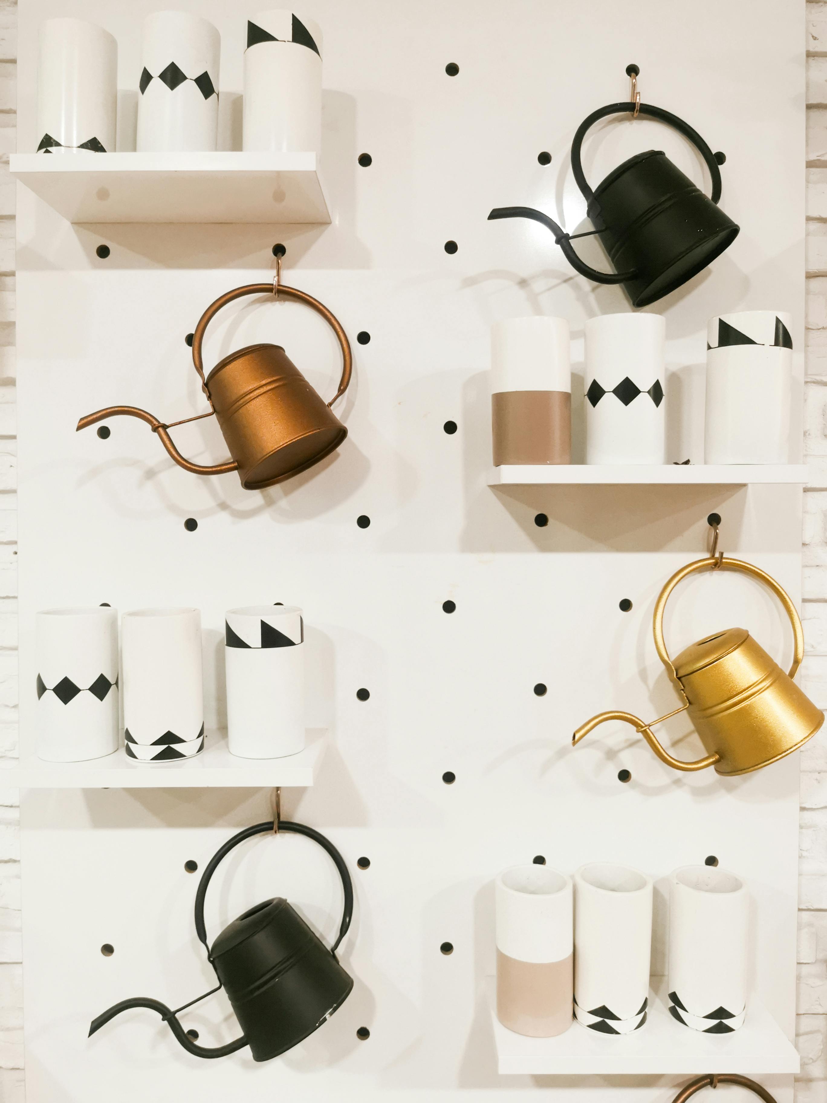 Antique Kettles Hanging on a Wall · Free Stock Photo