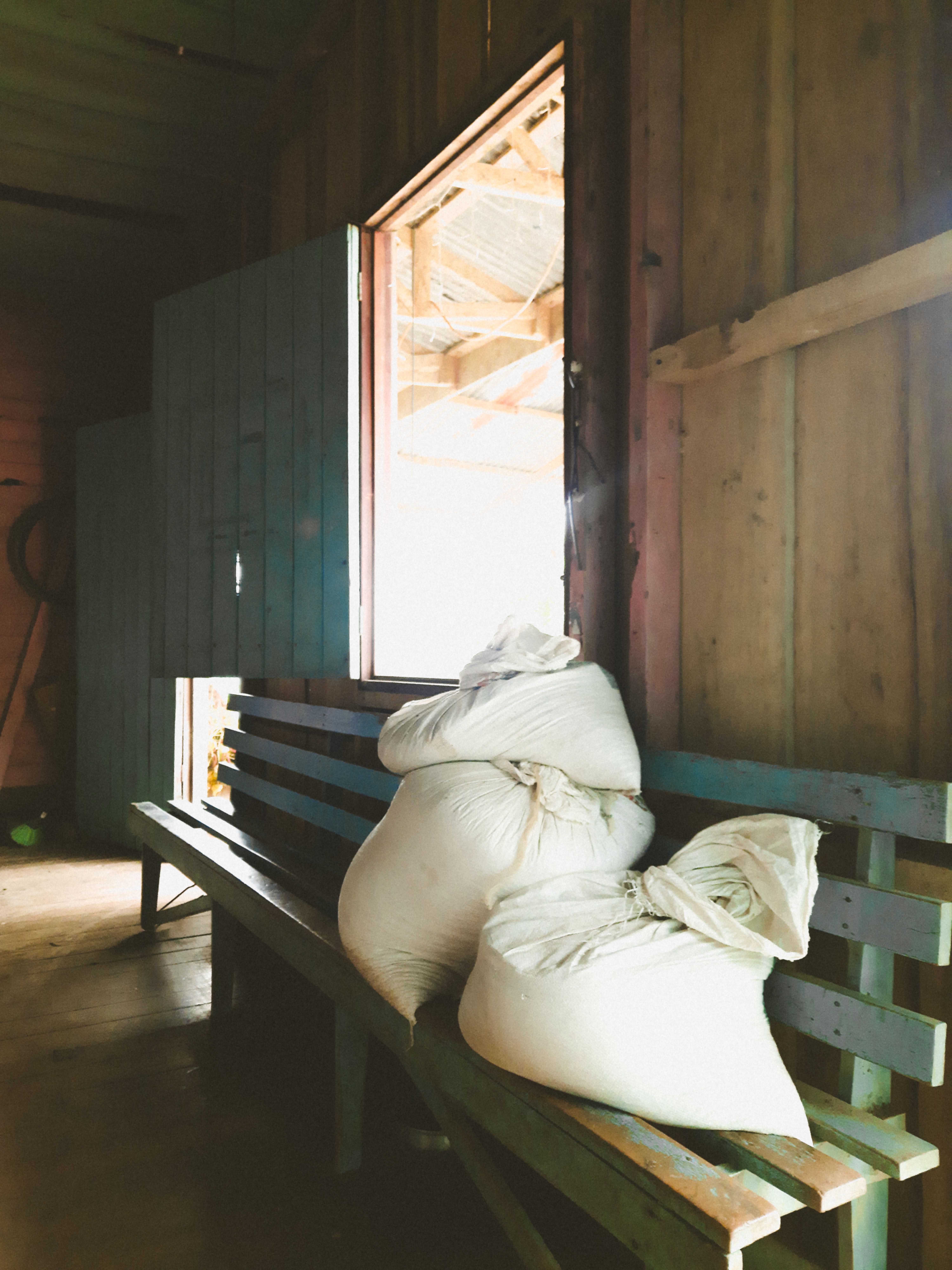 White Filled Sacks on a Wooden Bench · Free Stock Photo