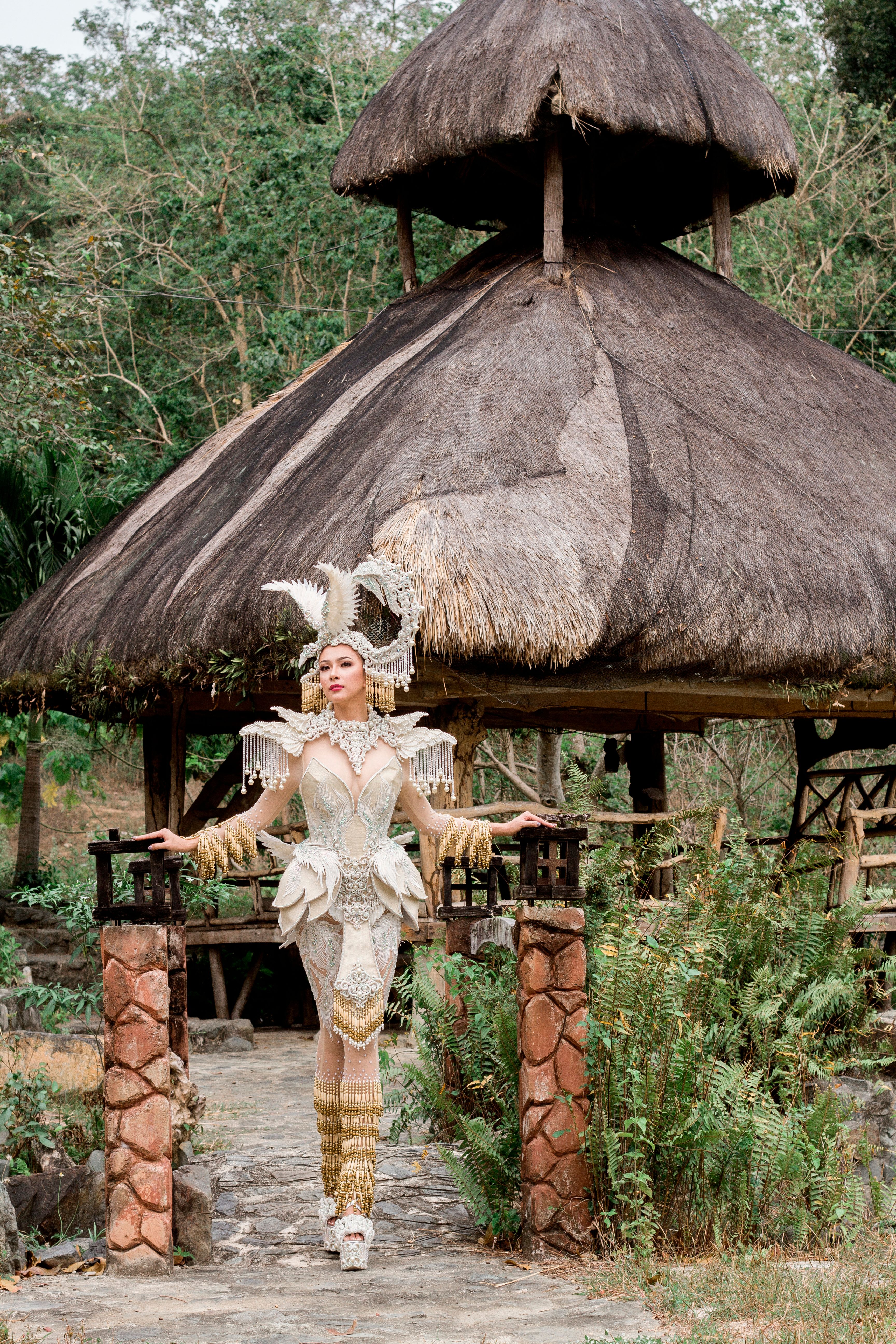 Beautiful Woman in a Costume standing near a Hut · Free Stock Photo