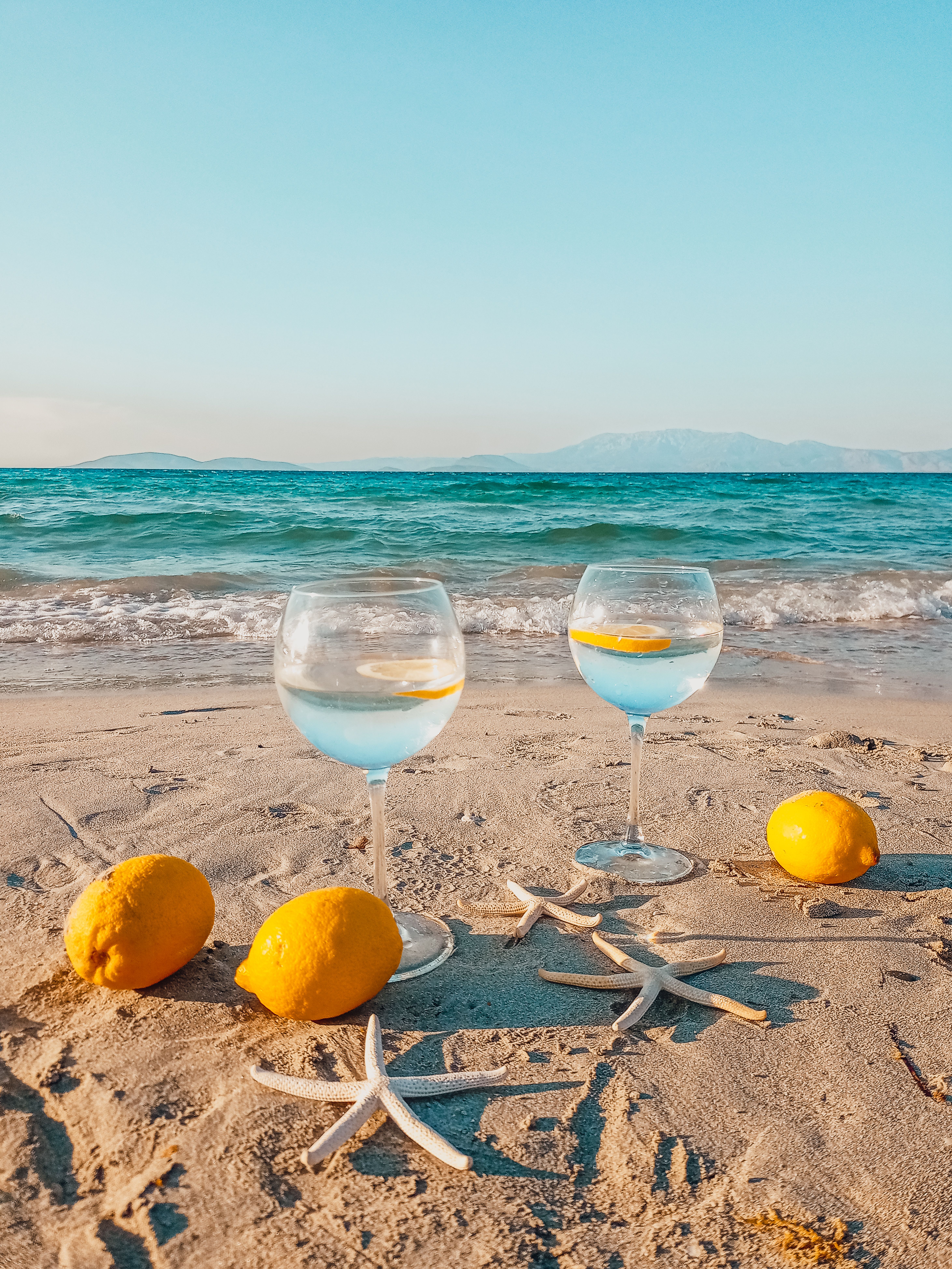 Wine Glasses and Lemons on Sand · Free Stock Photo