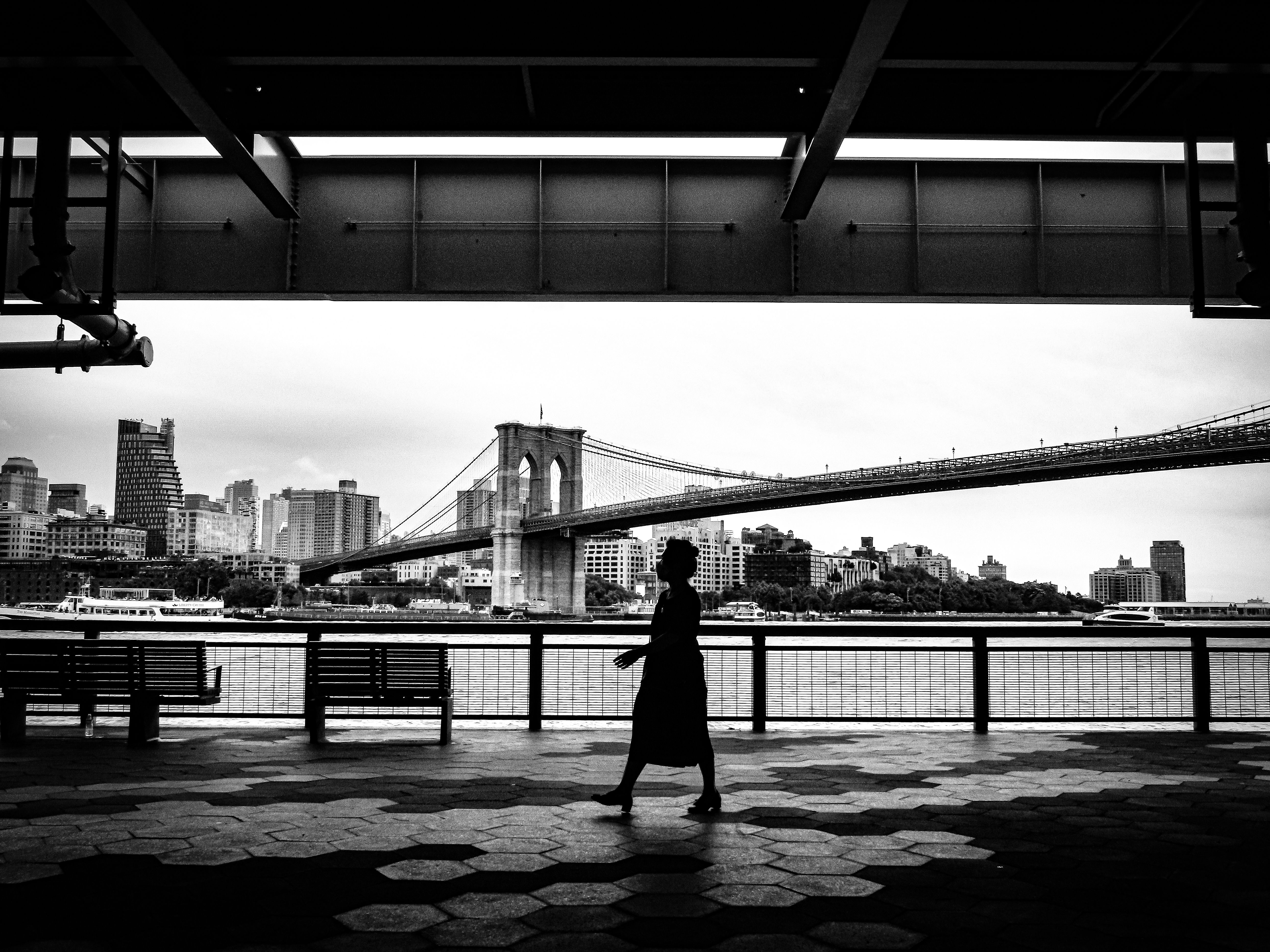 Silhouette of a Person Walking Under the Bridge · Free Stock Photo