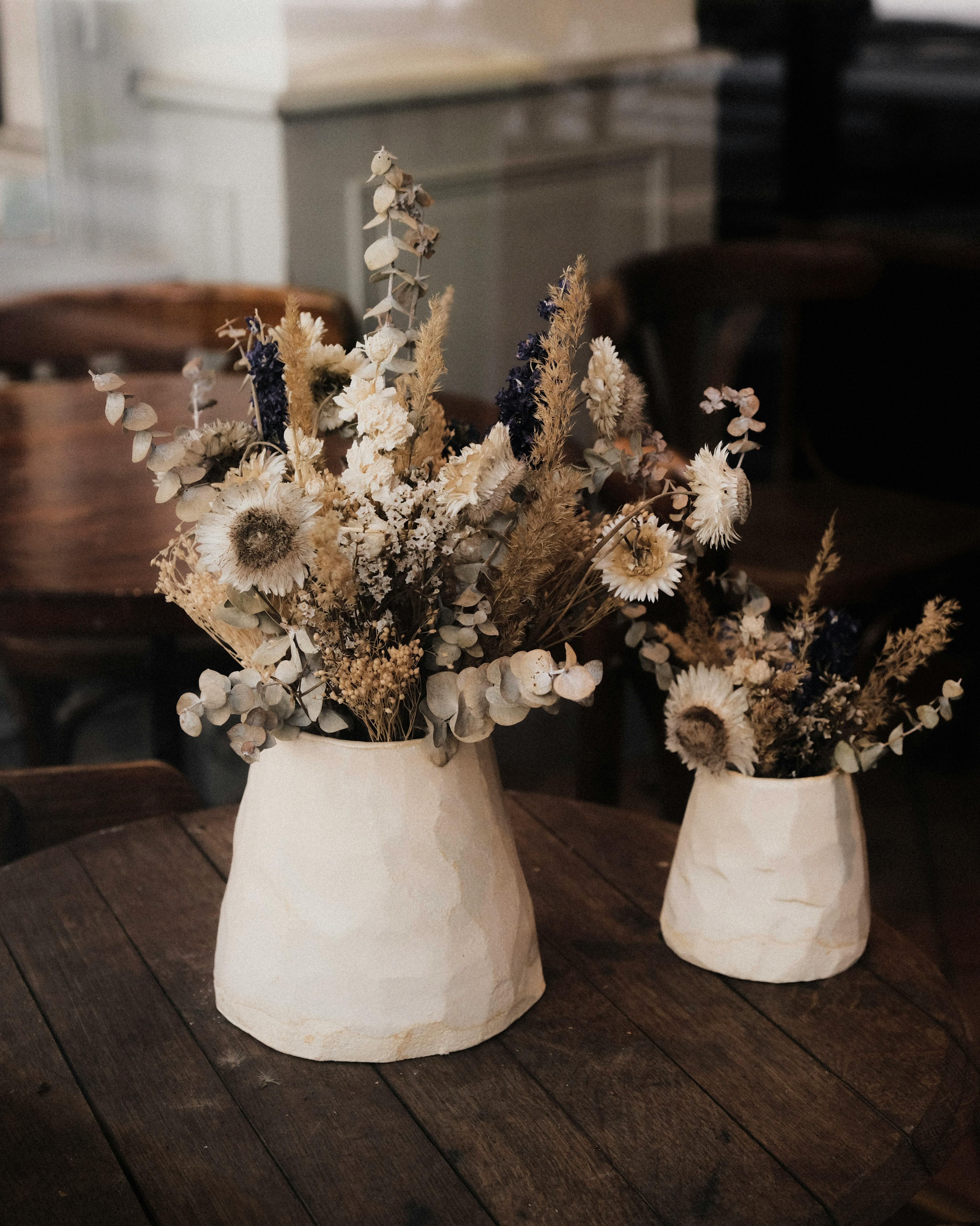 Dried Flowers in a Vase Near a White Wall · Free Stock Photo