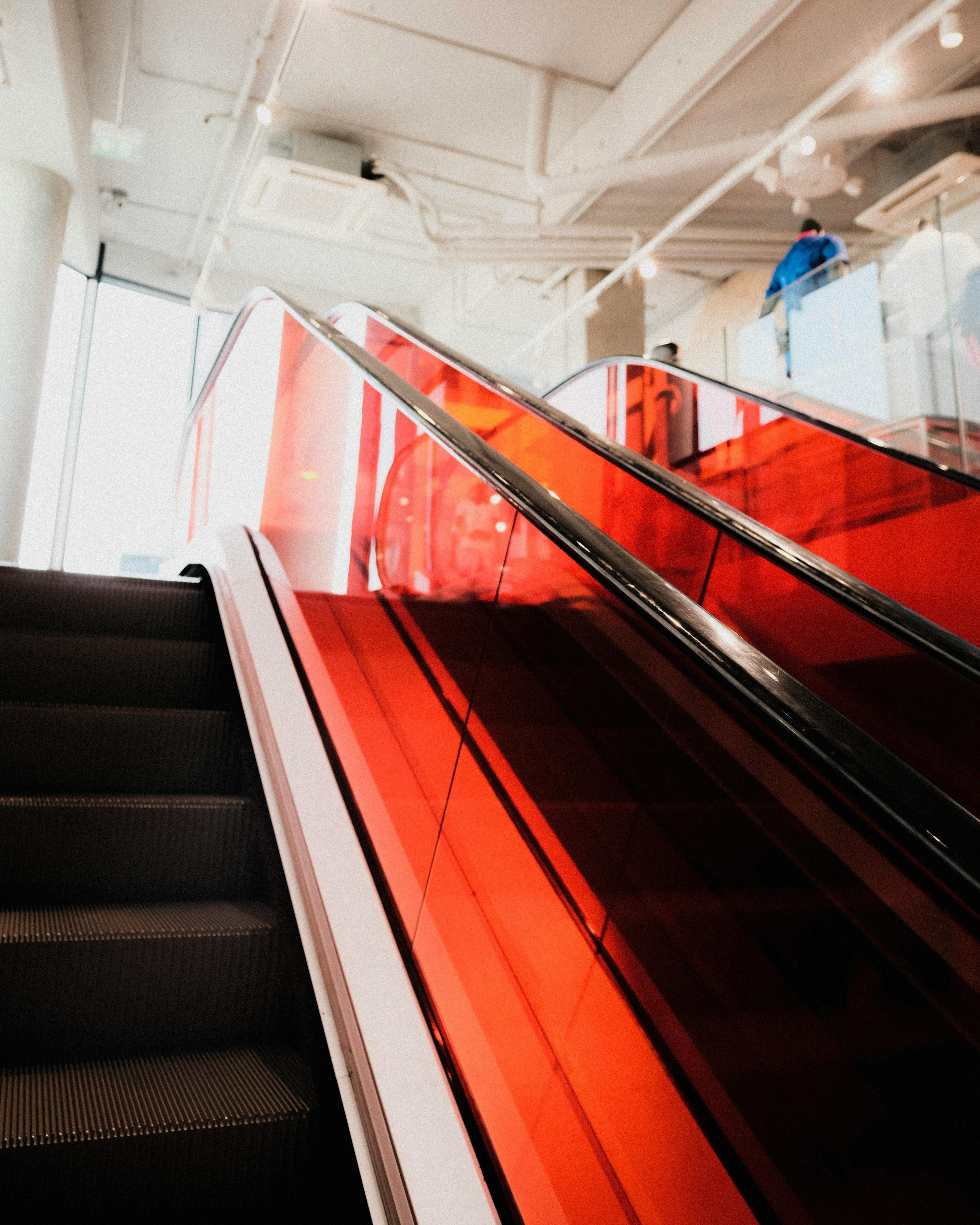 An Escalator with Red Colored Panels · Free Stock Photo