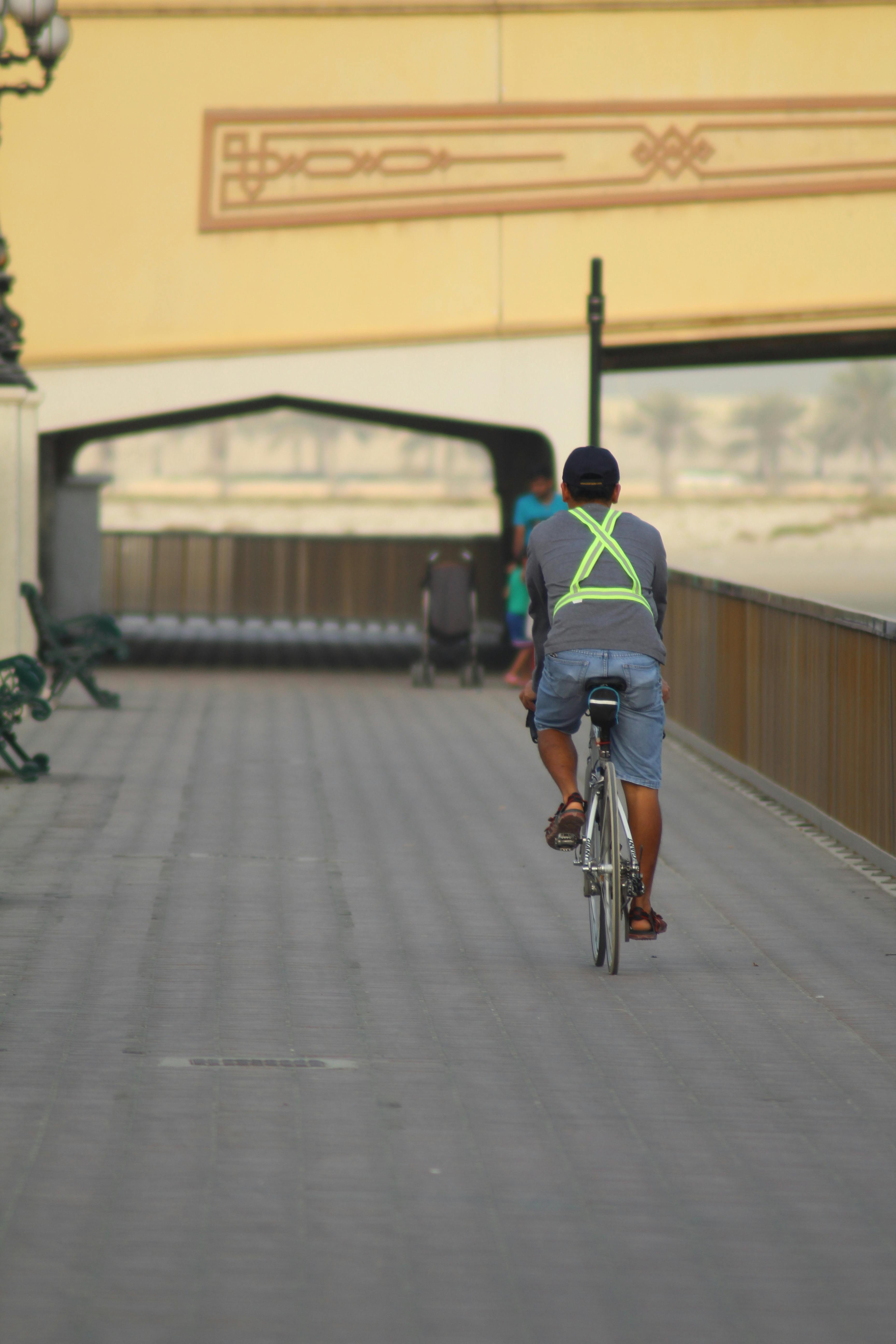 Back View of a Man Riding a Bicycle · Free Stock Photo