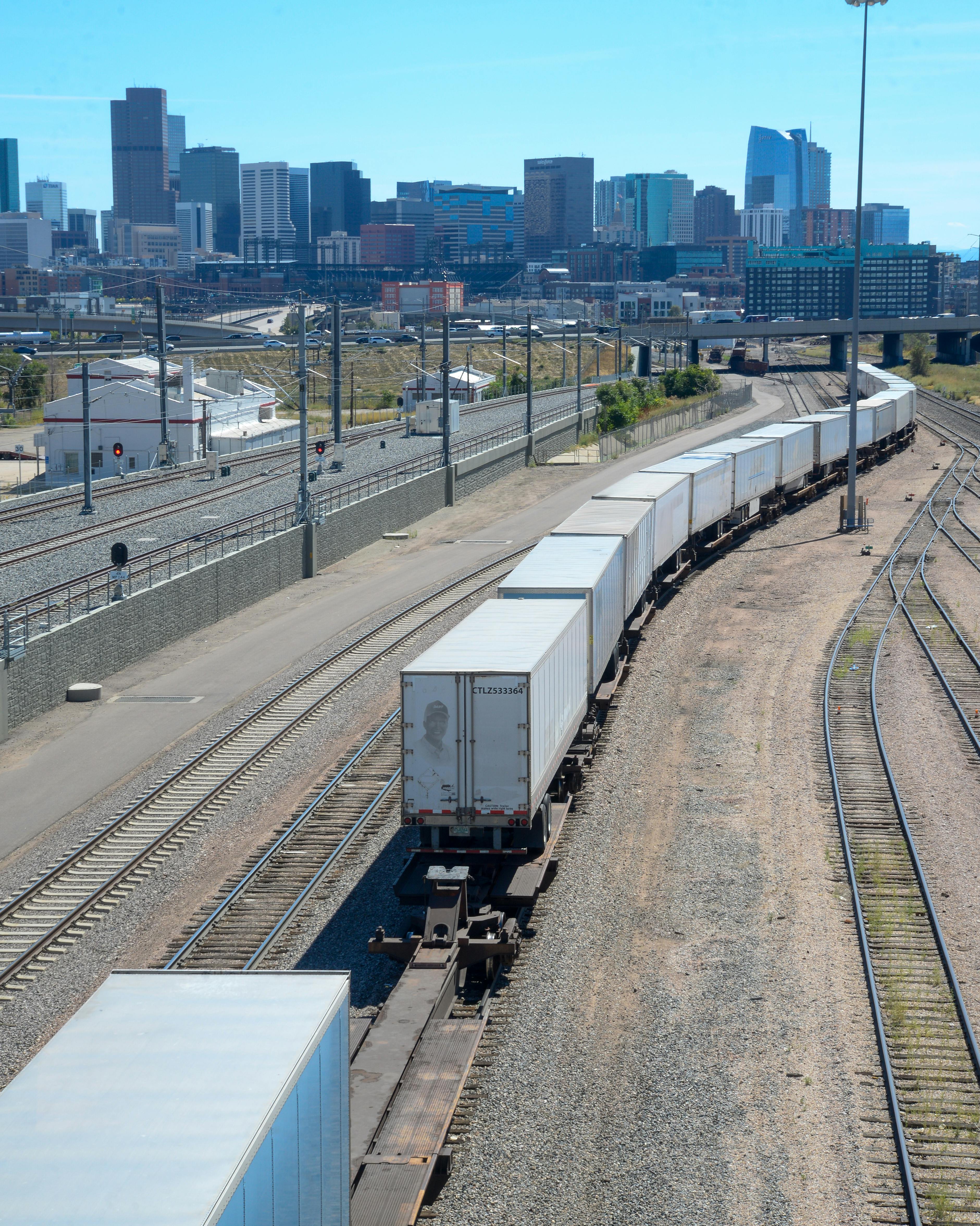 An Aerial Photography of a Cargo Train Near the City Buildings · Free ...