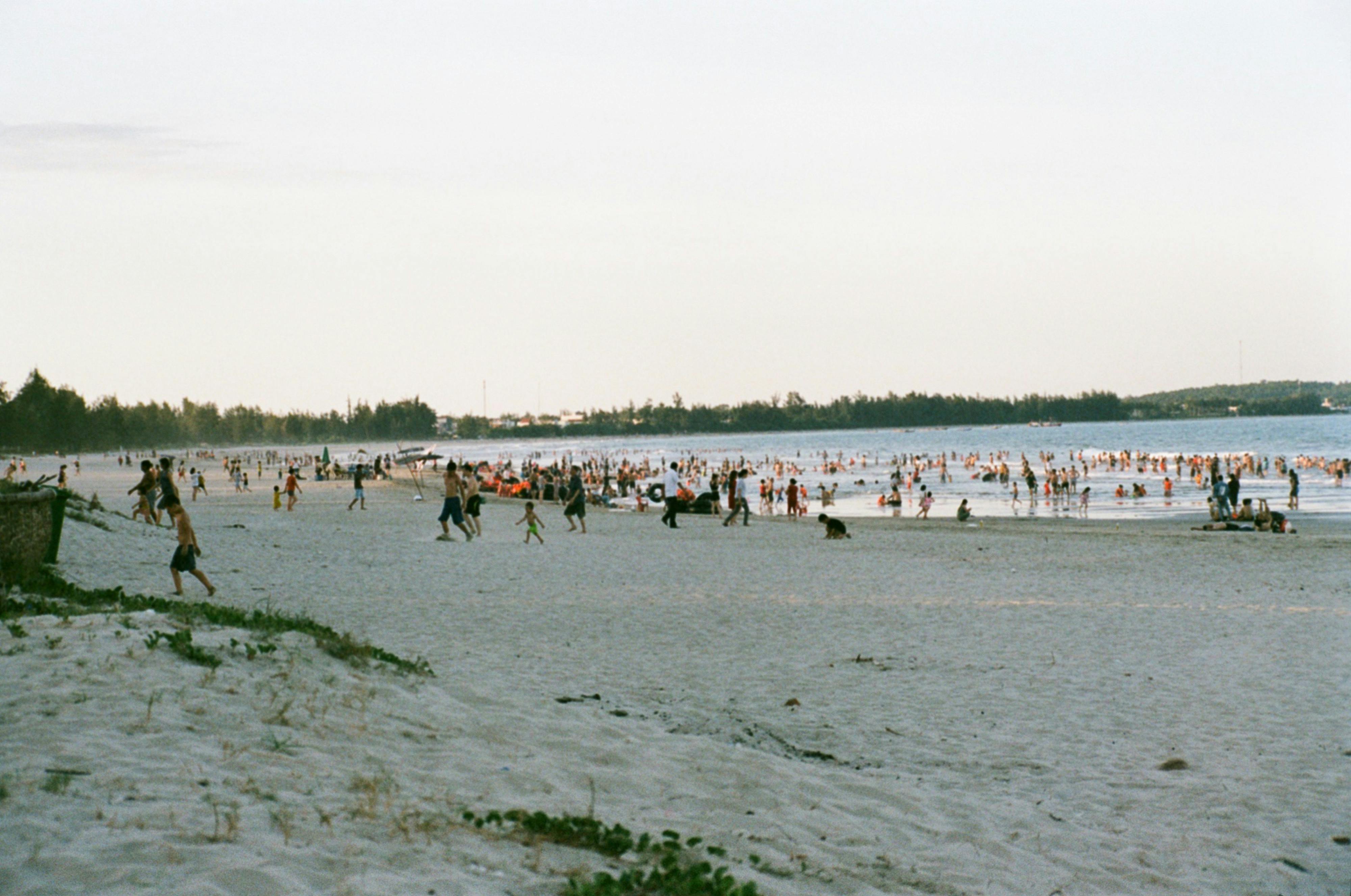 People Near Beach With Lifeguard Gazebo · Free Stock Photo