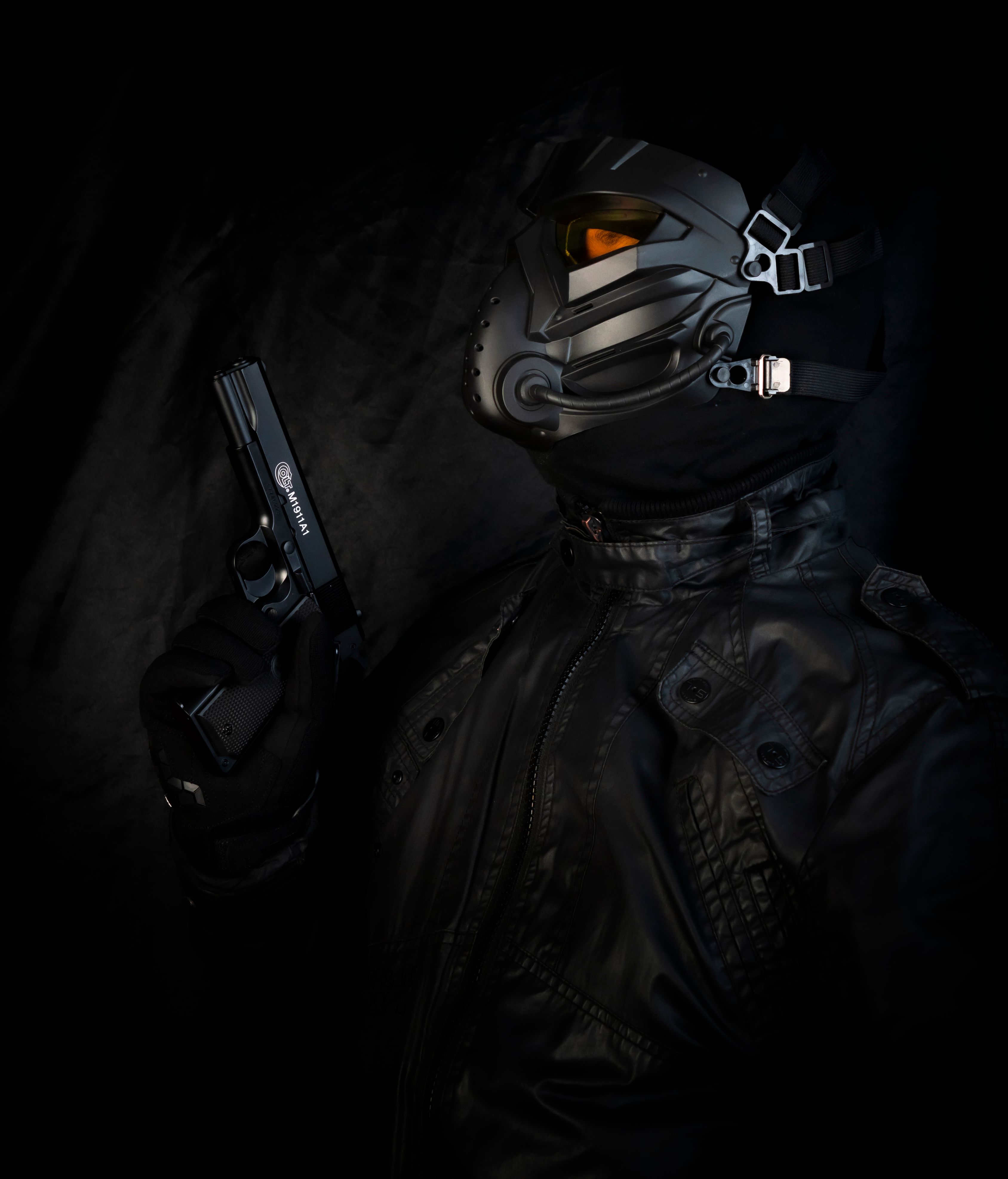 A Man in Black Jacket and Mask Holding a Handgun · Free Stock Photo