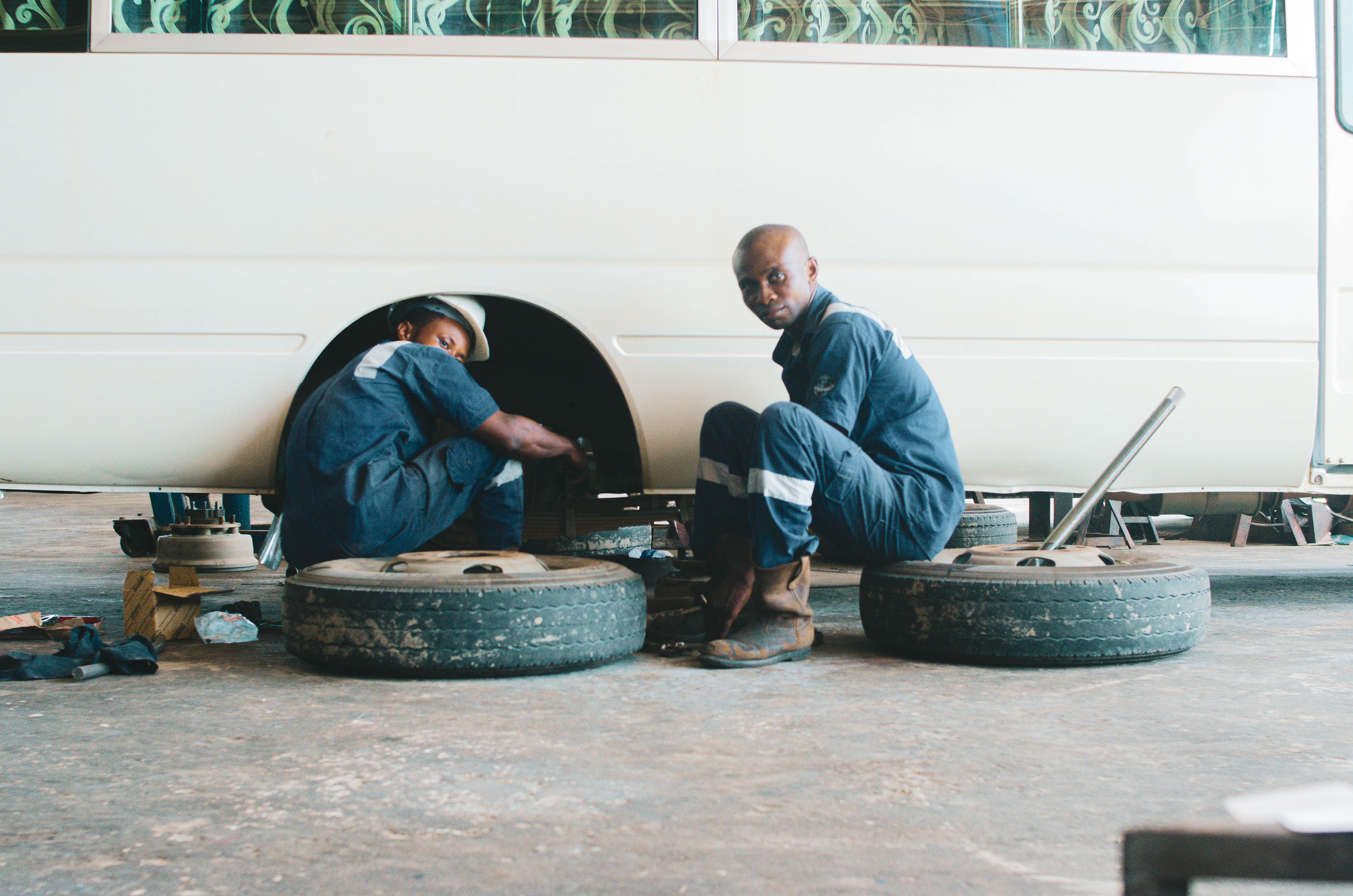A Man Fixing a Flat Tire · Free Stock Photo