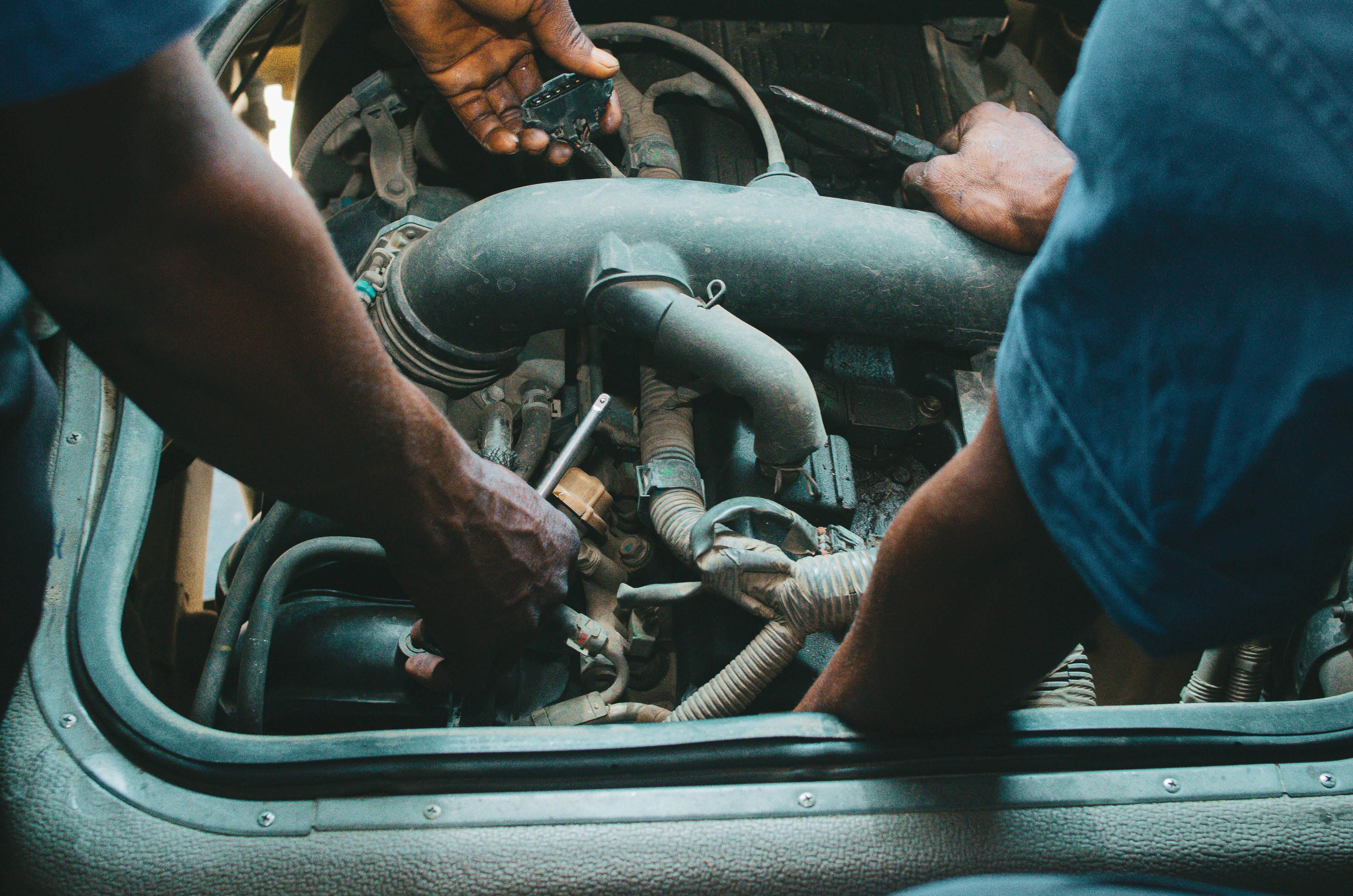Mechanics working on an Engine · Free Stock Photo
