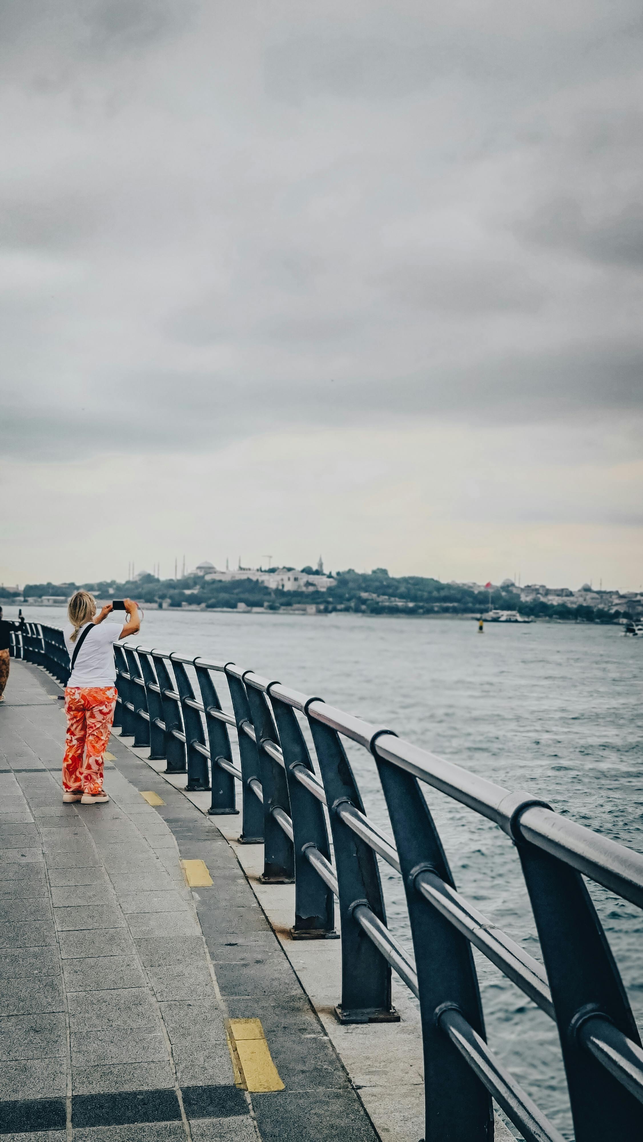 Person standing on a Bridge by the Riverside · Free Stock Photo