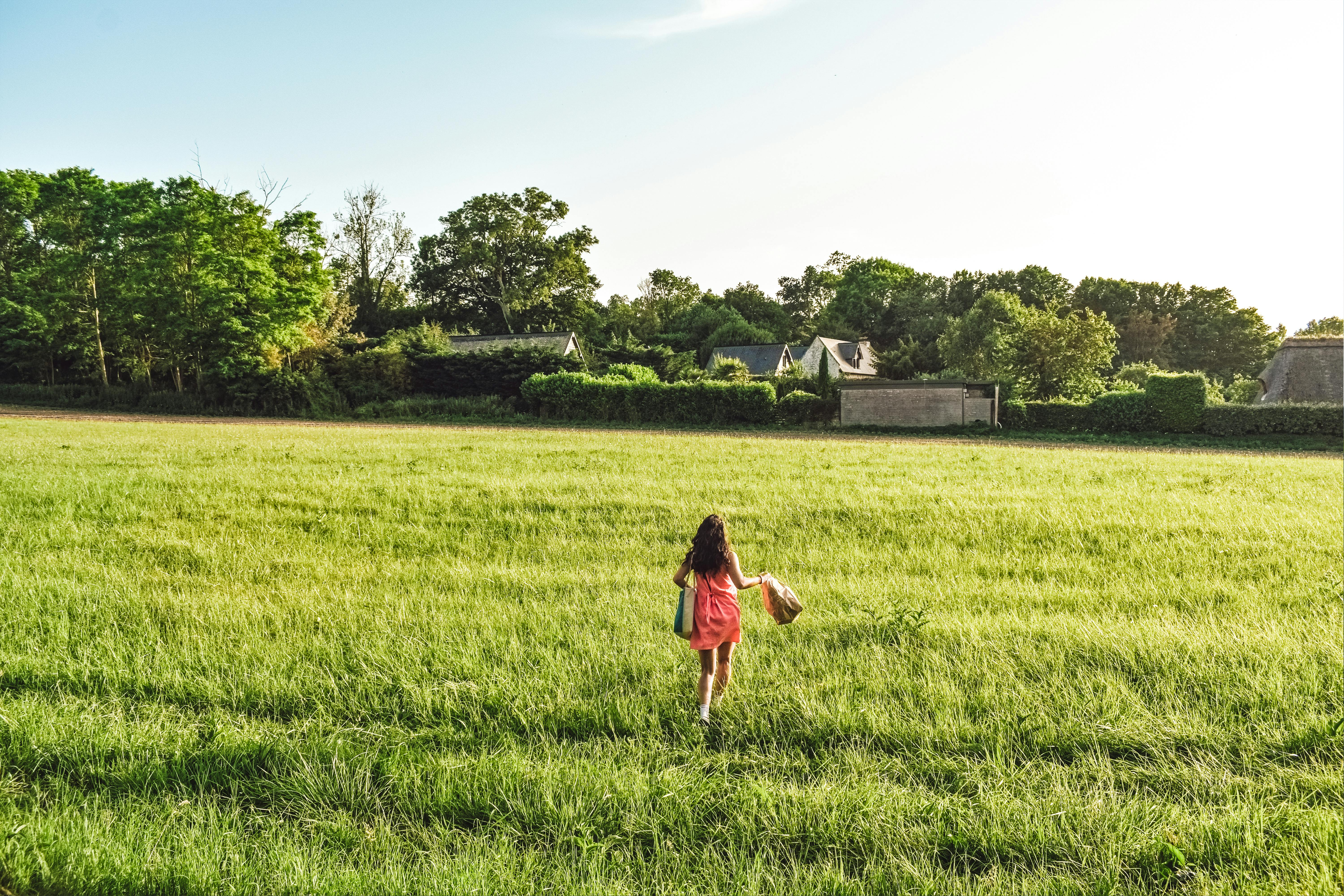 Woman Running on Grass Field · Free Stock Photo