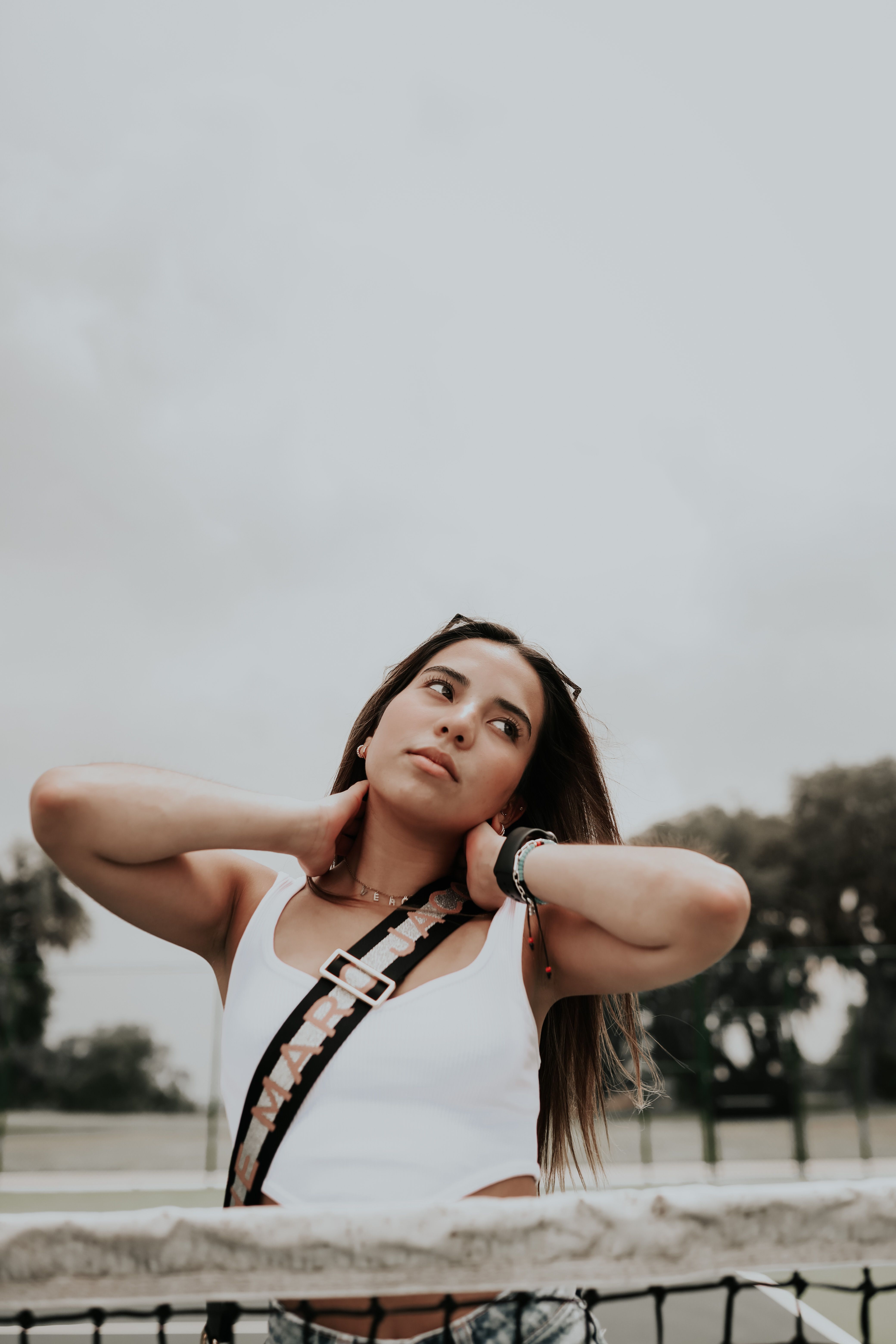 Photo of a Young Woman Standing with Hands Raised · Free Stock Photo