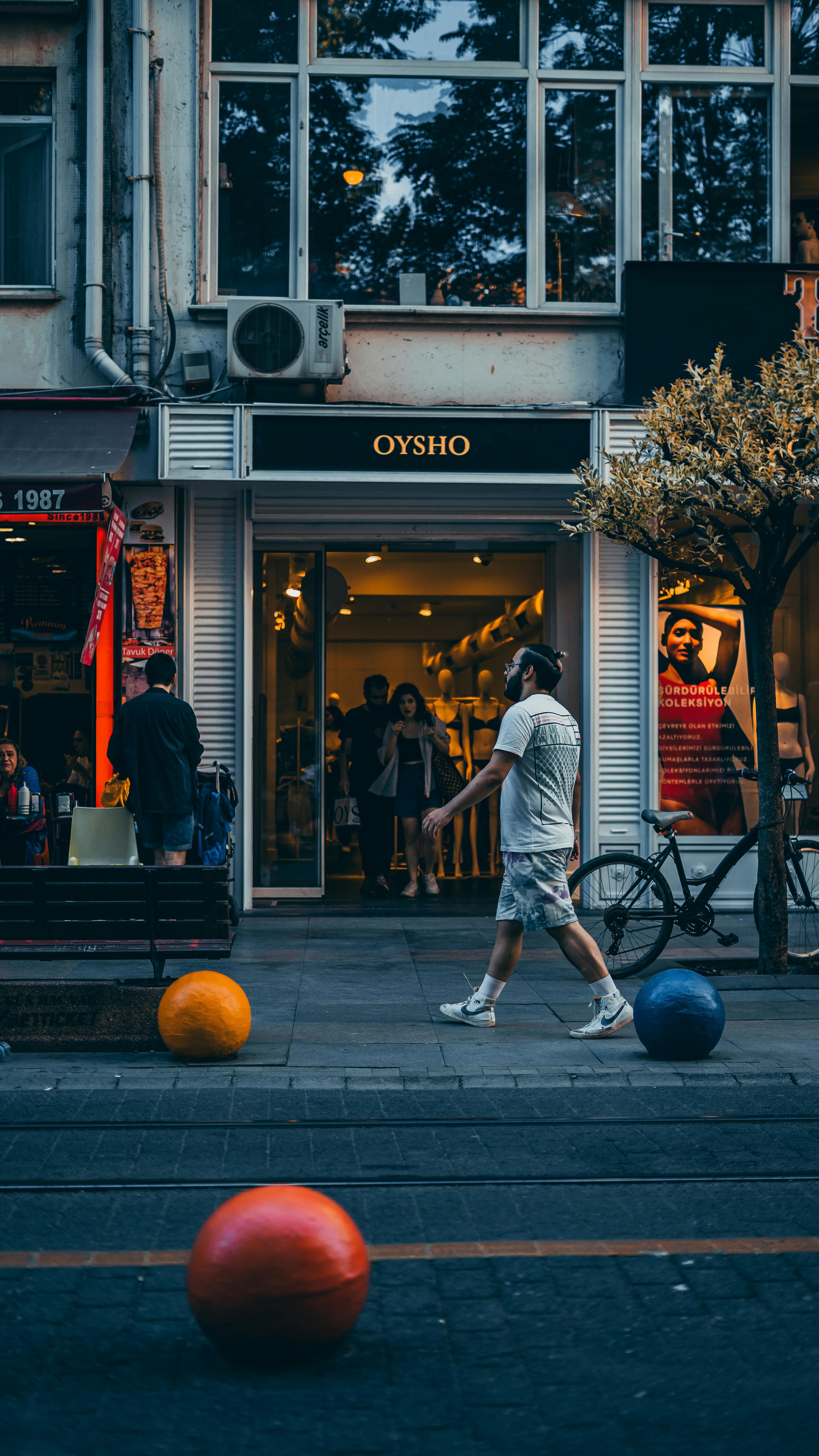 People Walking Out of a Clothing Store in City · Free Stock Photo