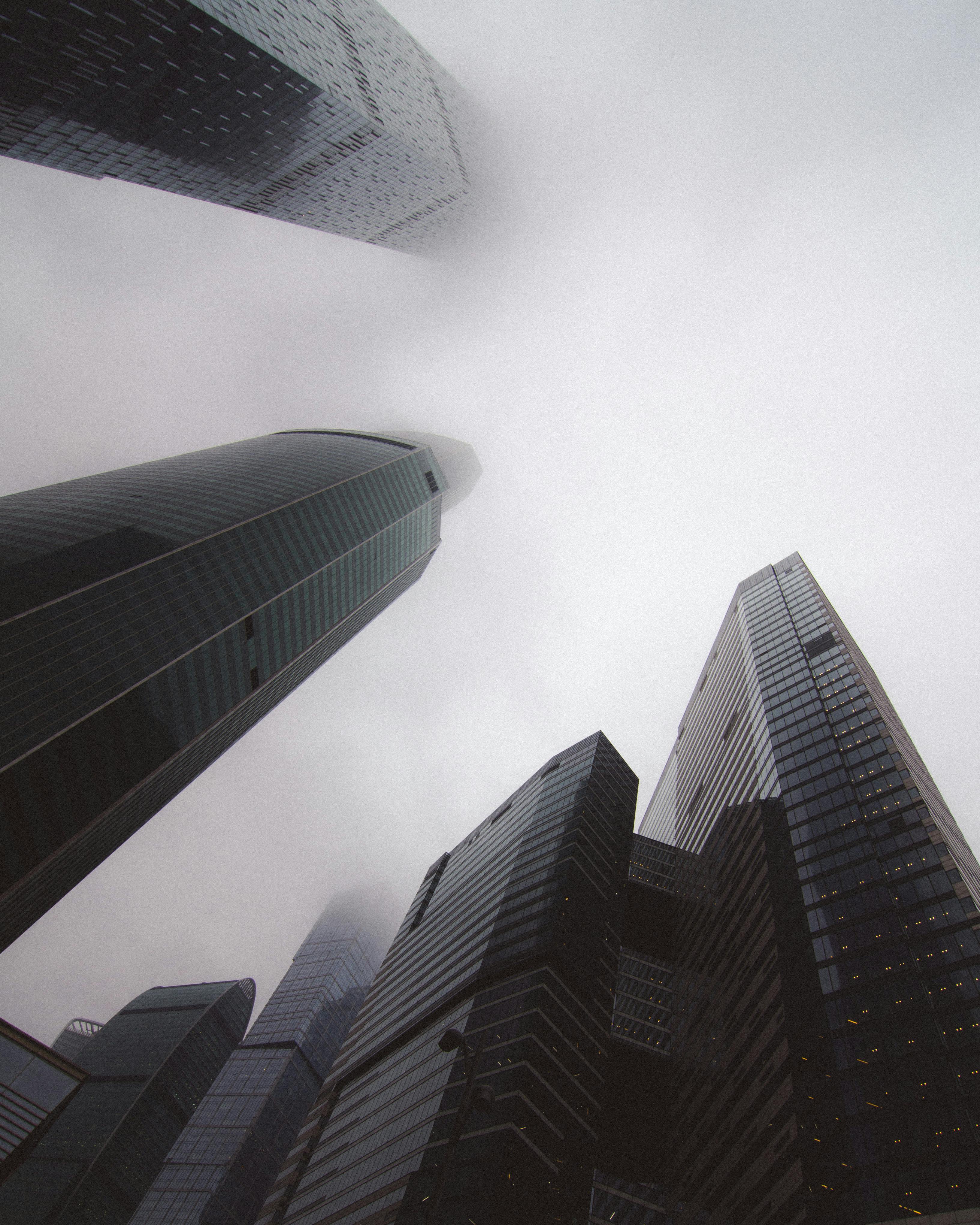 Low-angle Photography of Buildings Covered by Fog · Free Stock Photo