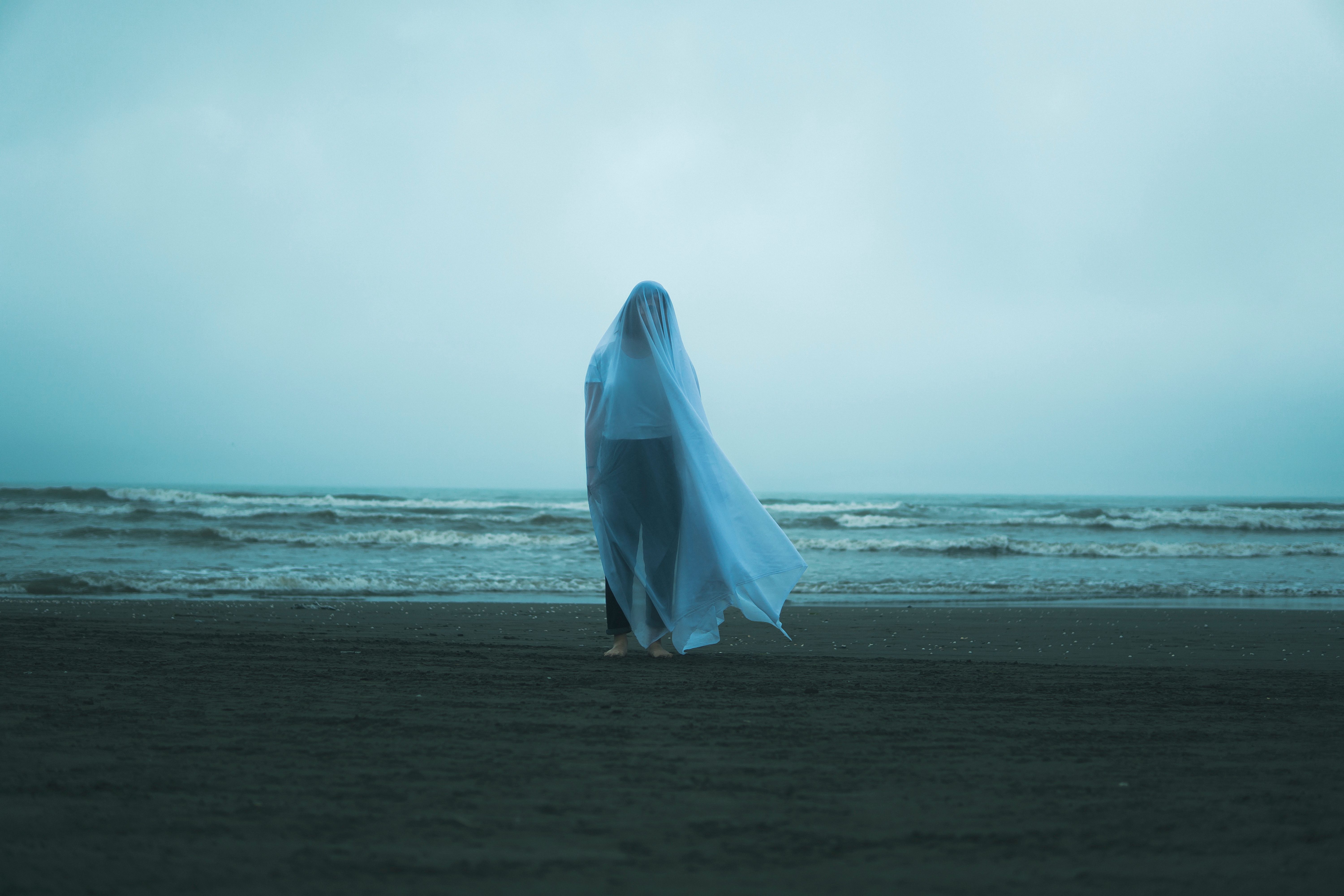 Wind Blowing on White Sheer Fabric Over Beach Shore · Free Stock Photo