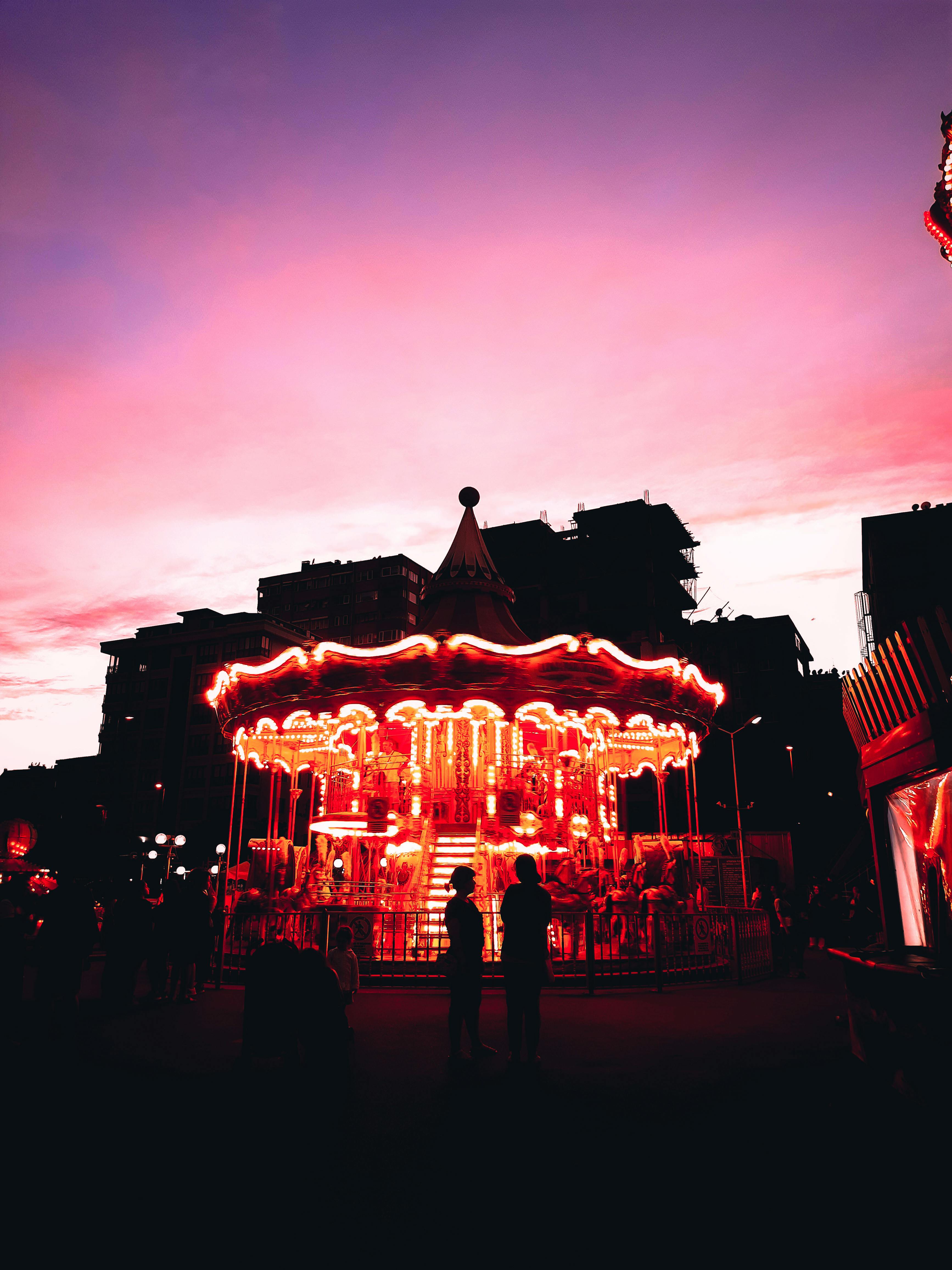 Girl Standing Near Carousel · Free Stock Photo