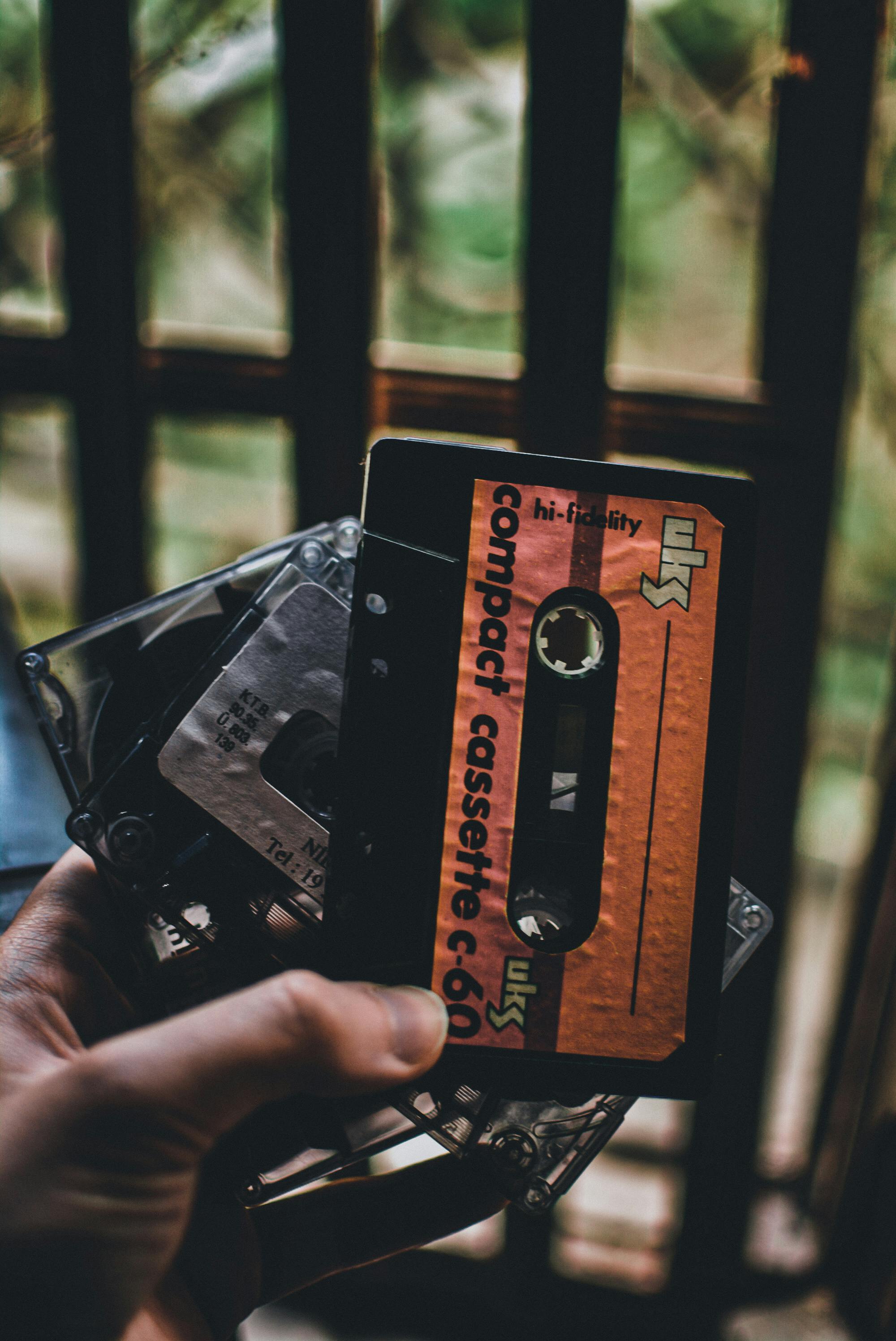 A Person Holding Cassette Tapes · Free Stock Photo