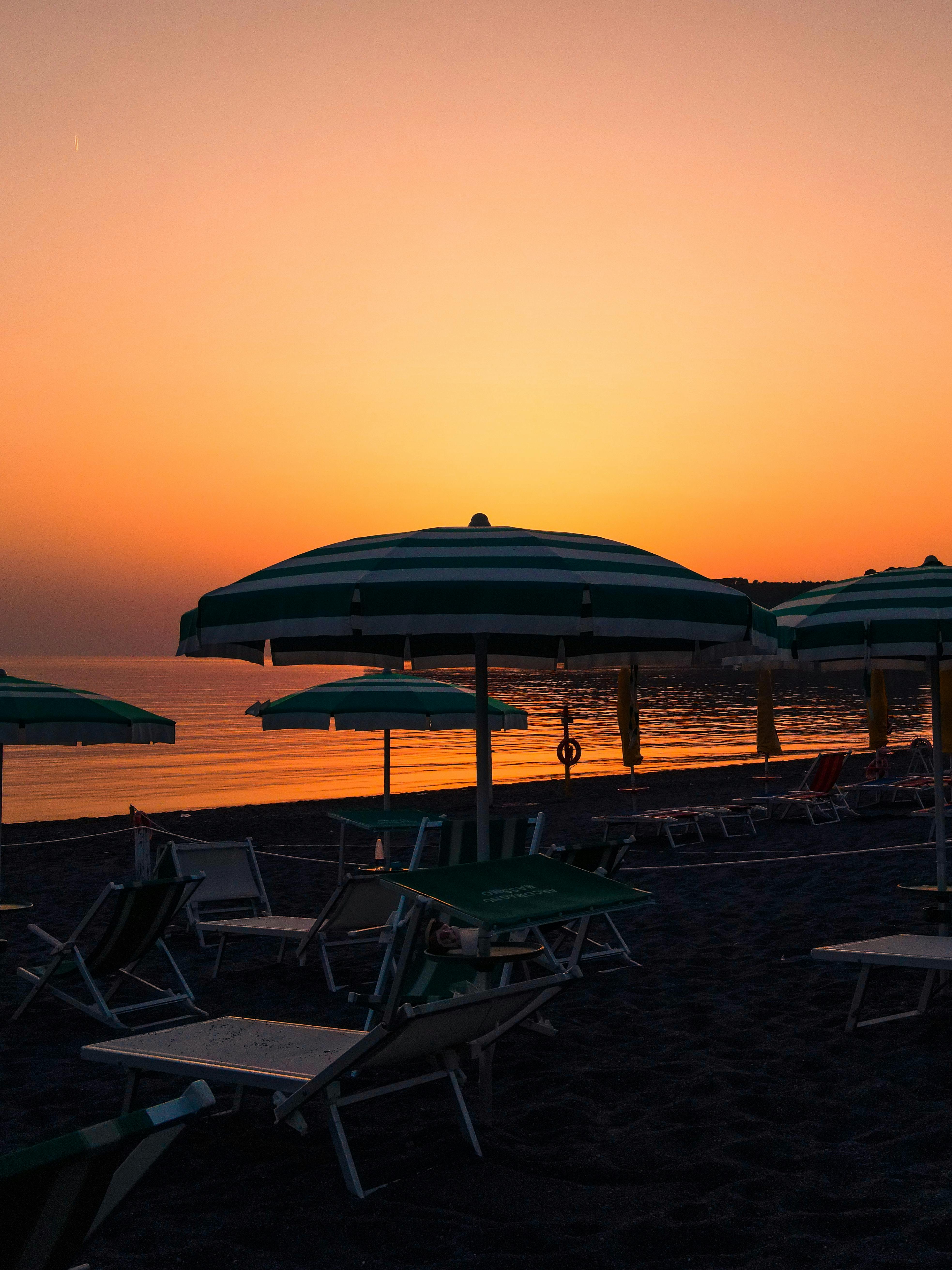 Silhouette of Beach Umbrellas During Sunset · Free Stock Photo
