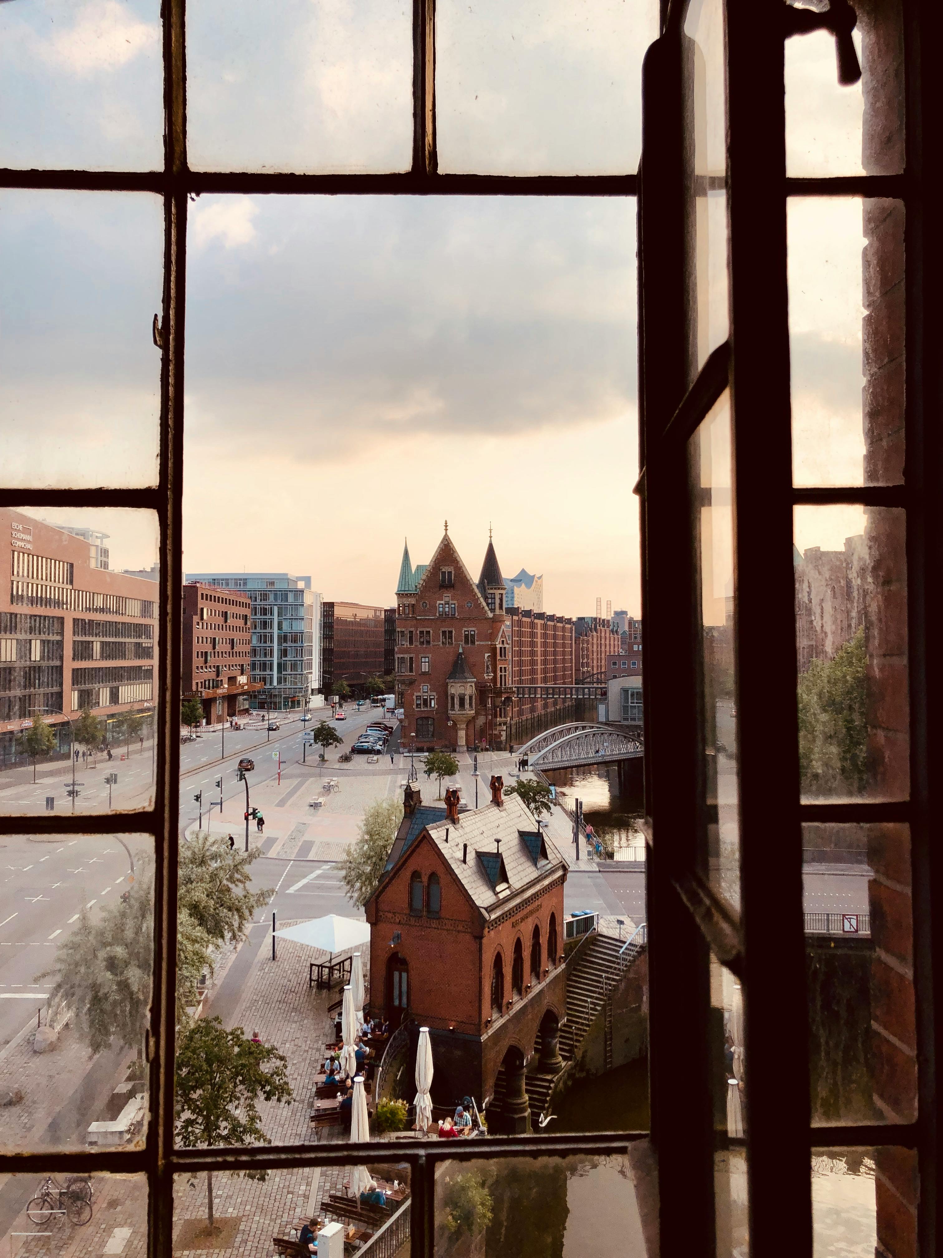 A View of City Buildings Through a Window · Free Stock Photo