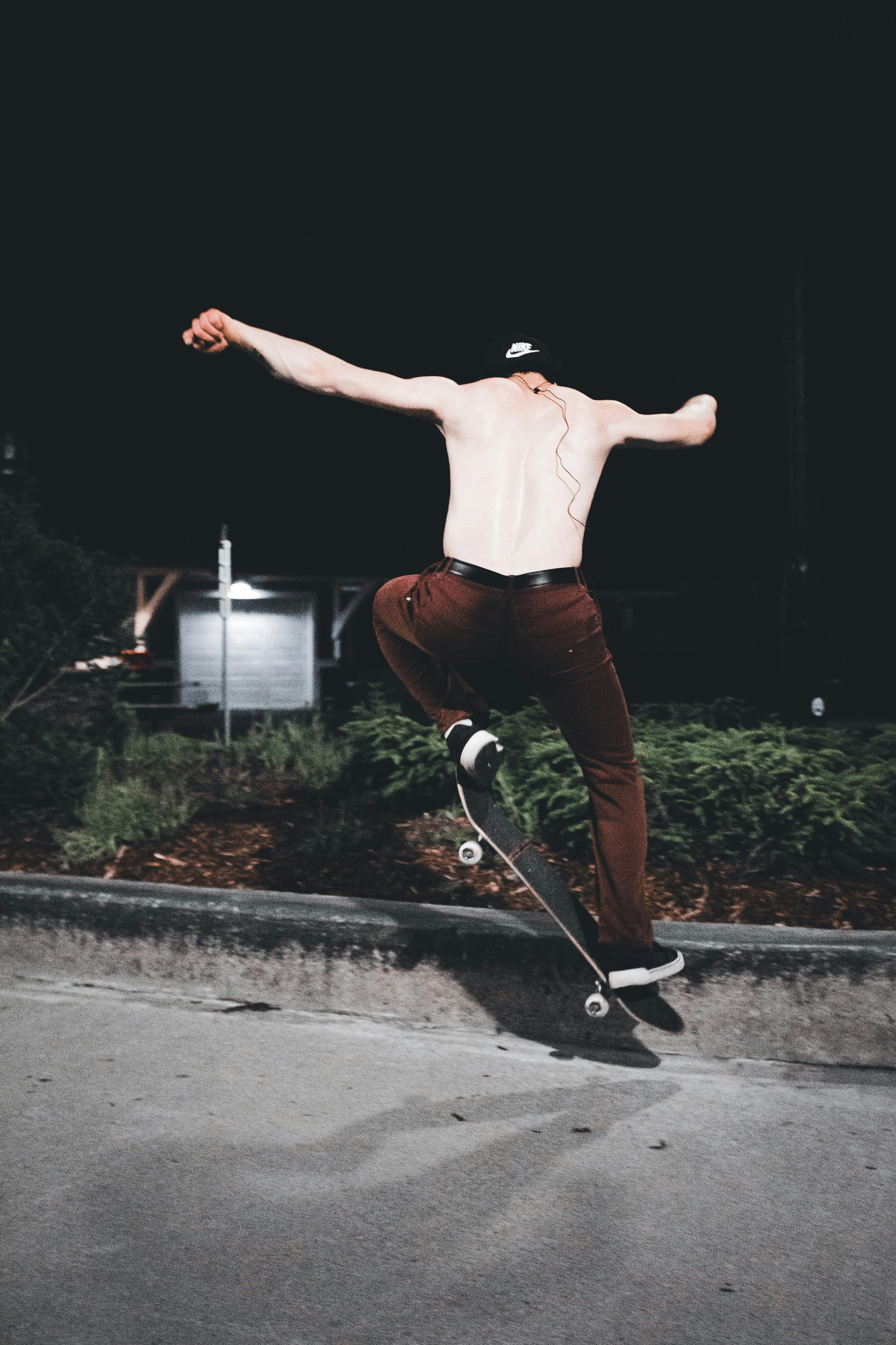 A Shirtless Man Skateboarding · Free Stock Photo