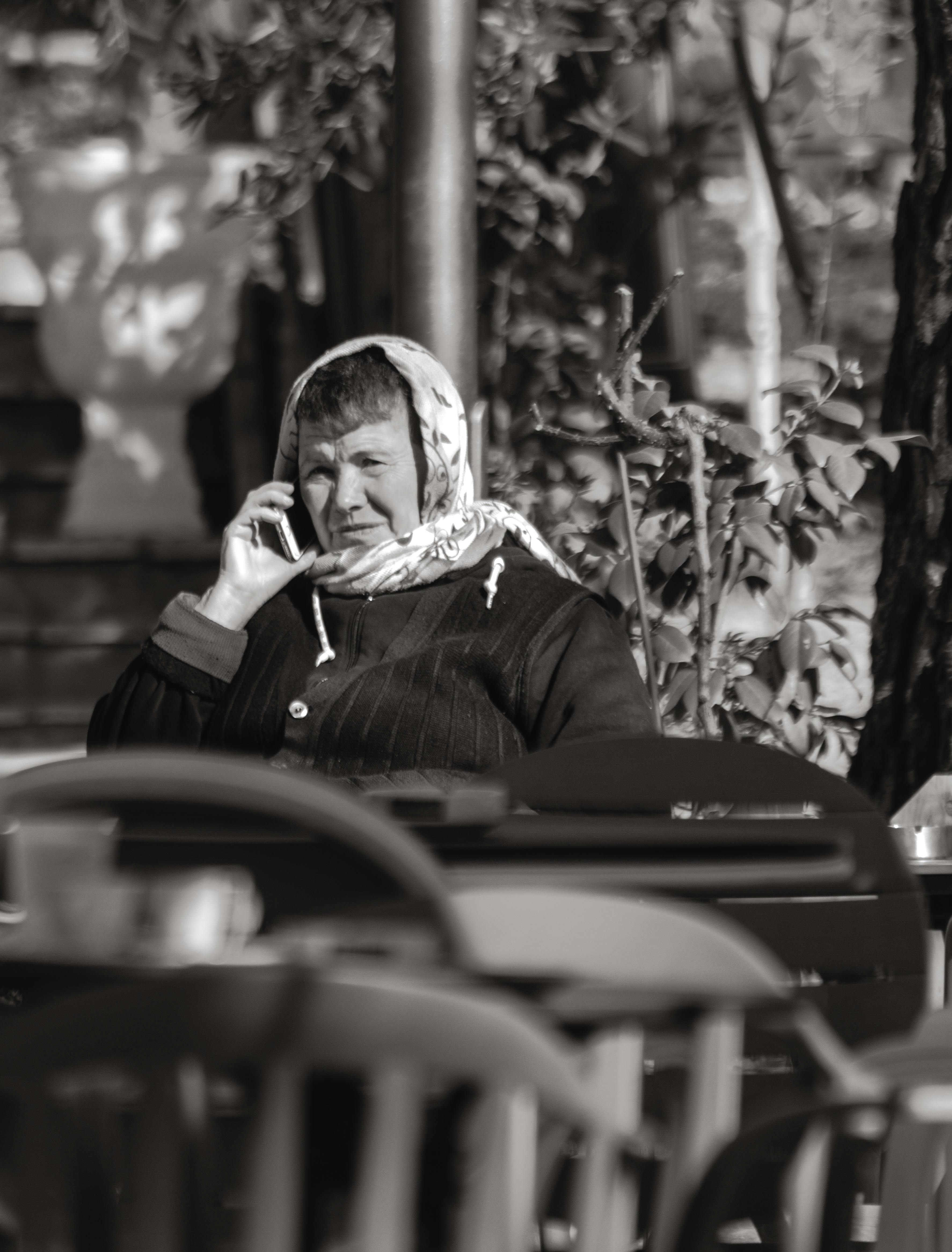 Woman Using a Payphone · Free Stock Photo