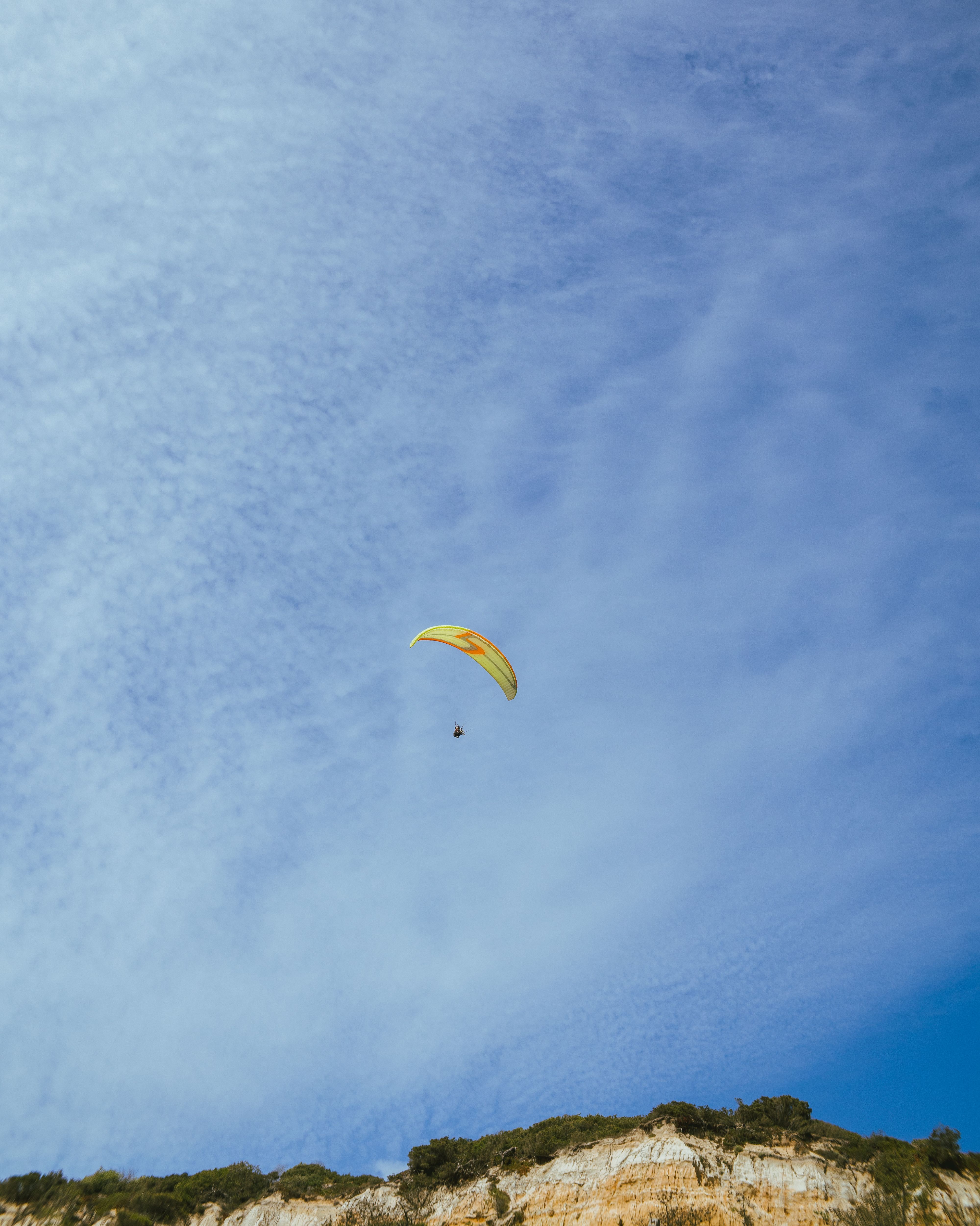 A Man Paragliding Over the Ocean · Free Stock Photo