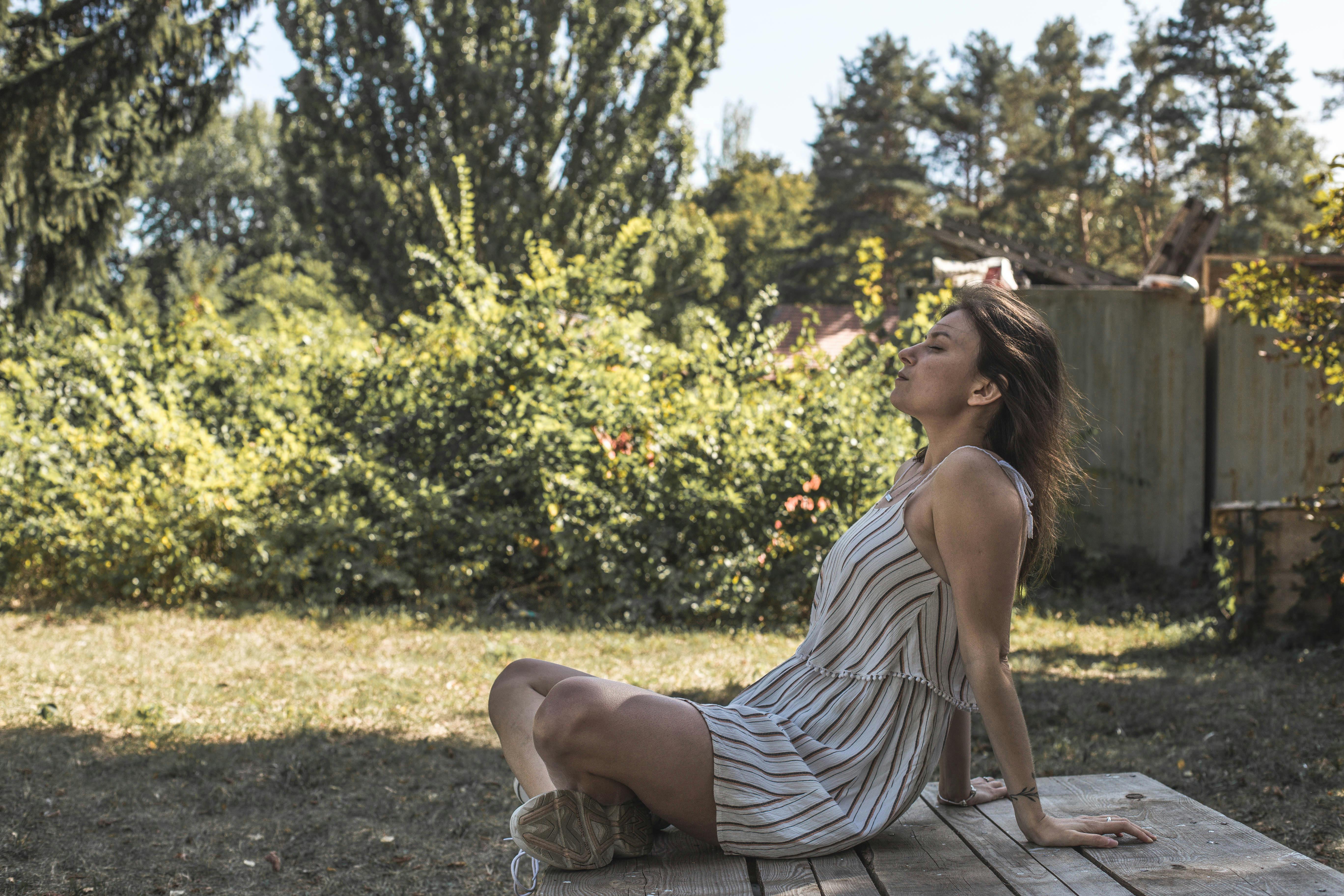 Photo of Woman Sitting on Wooden Crate · Free Stock Photo