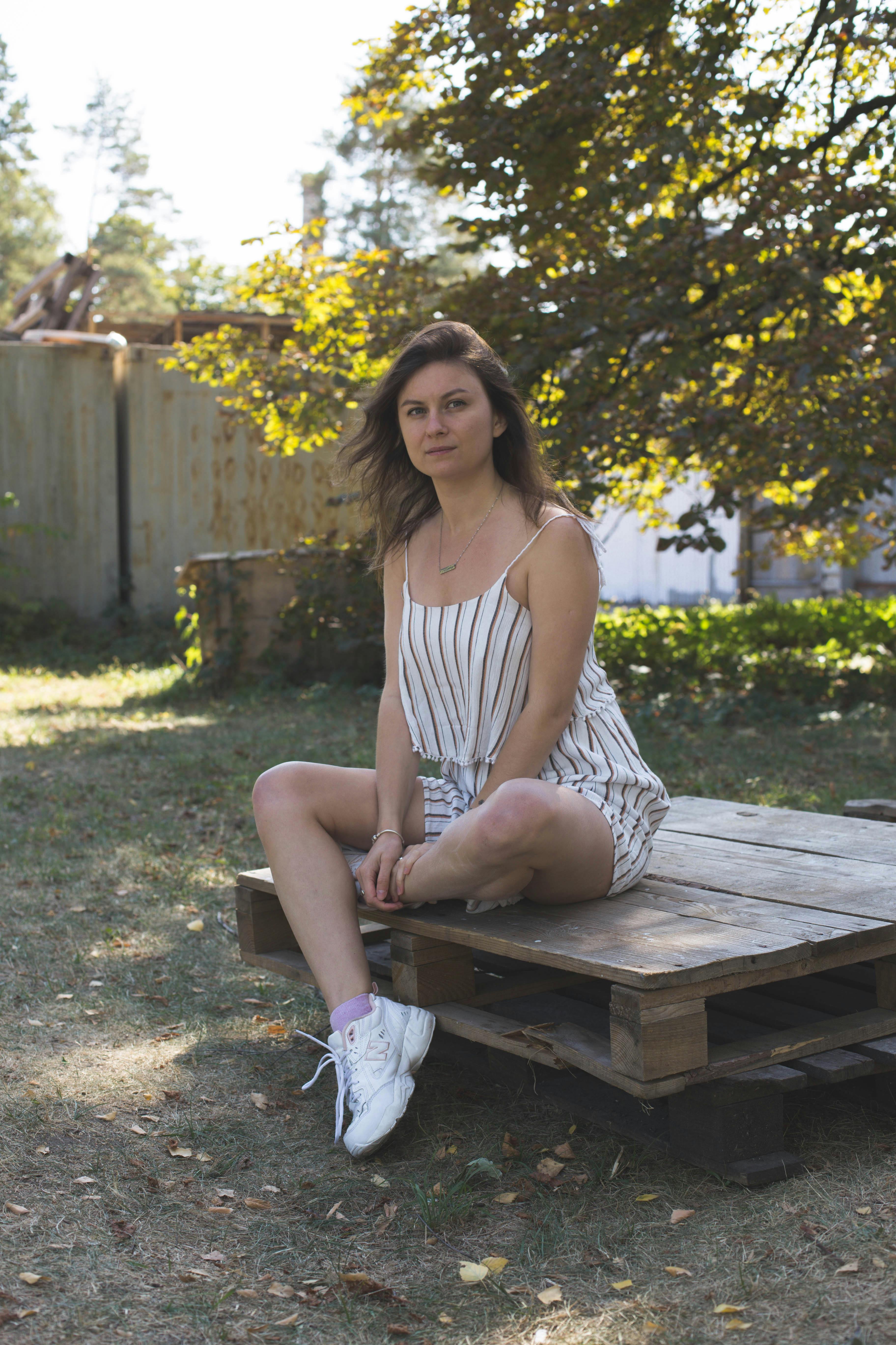 Beautiful Woman Sitting on Wooden Crate · Free Stock Photo