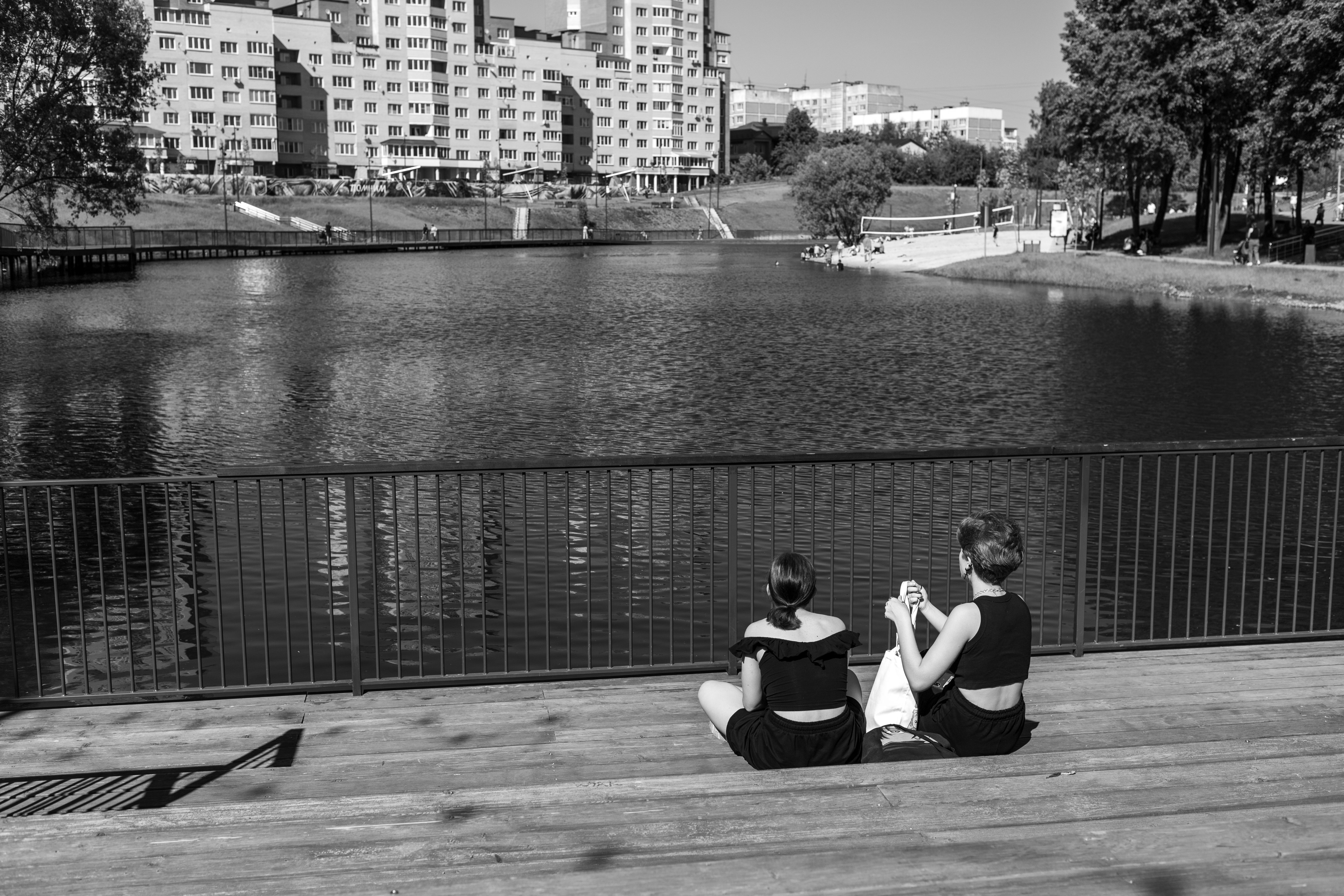 People Sitting Beside a Lake · Free Stock Photo