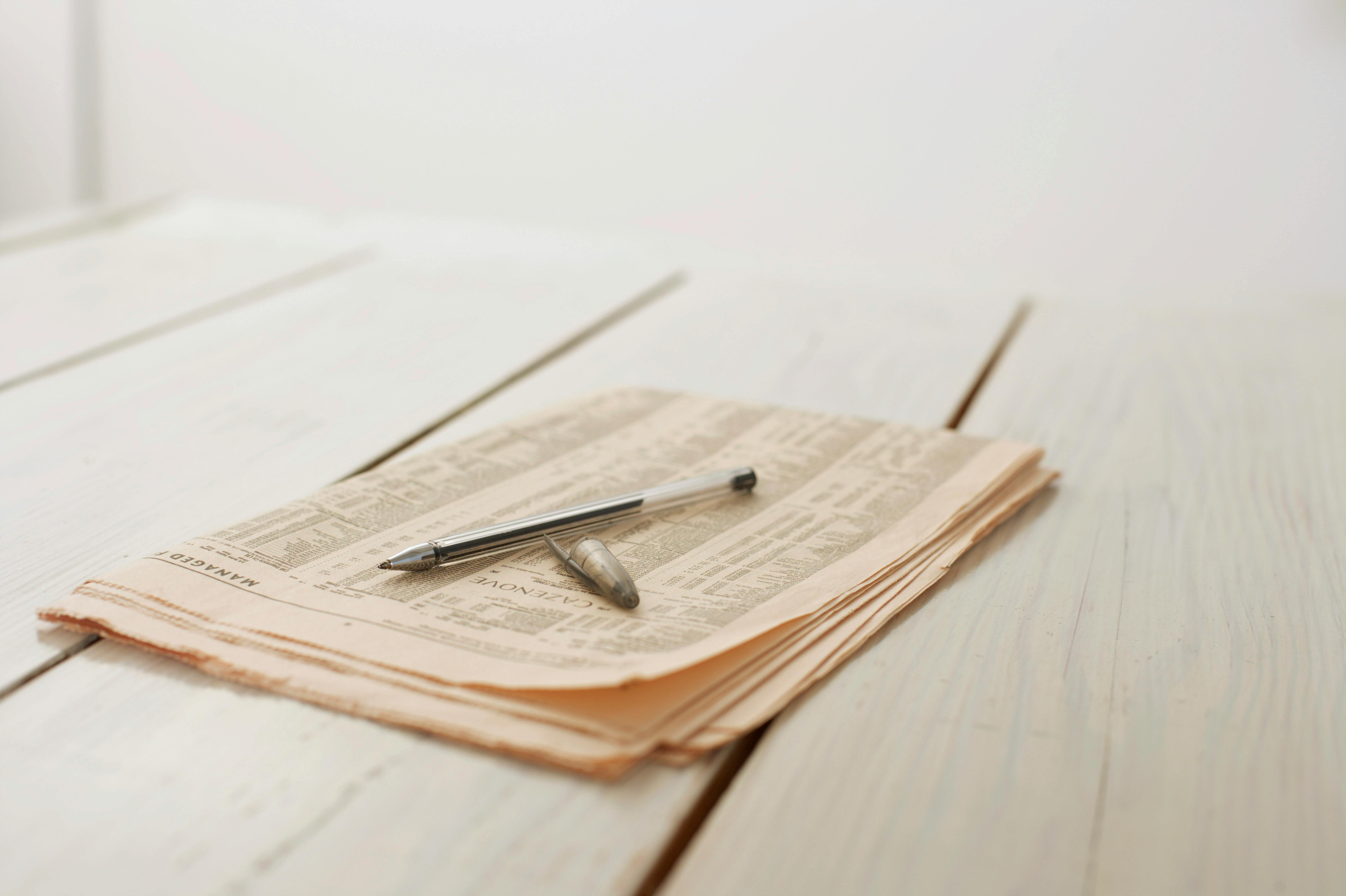 Free stock photo of macro, newspaper, notebook, pen, table