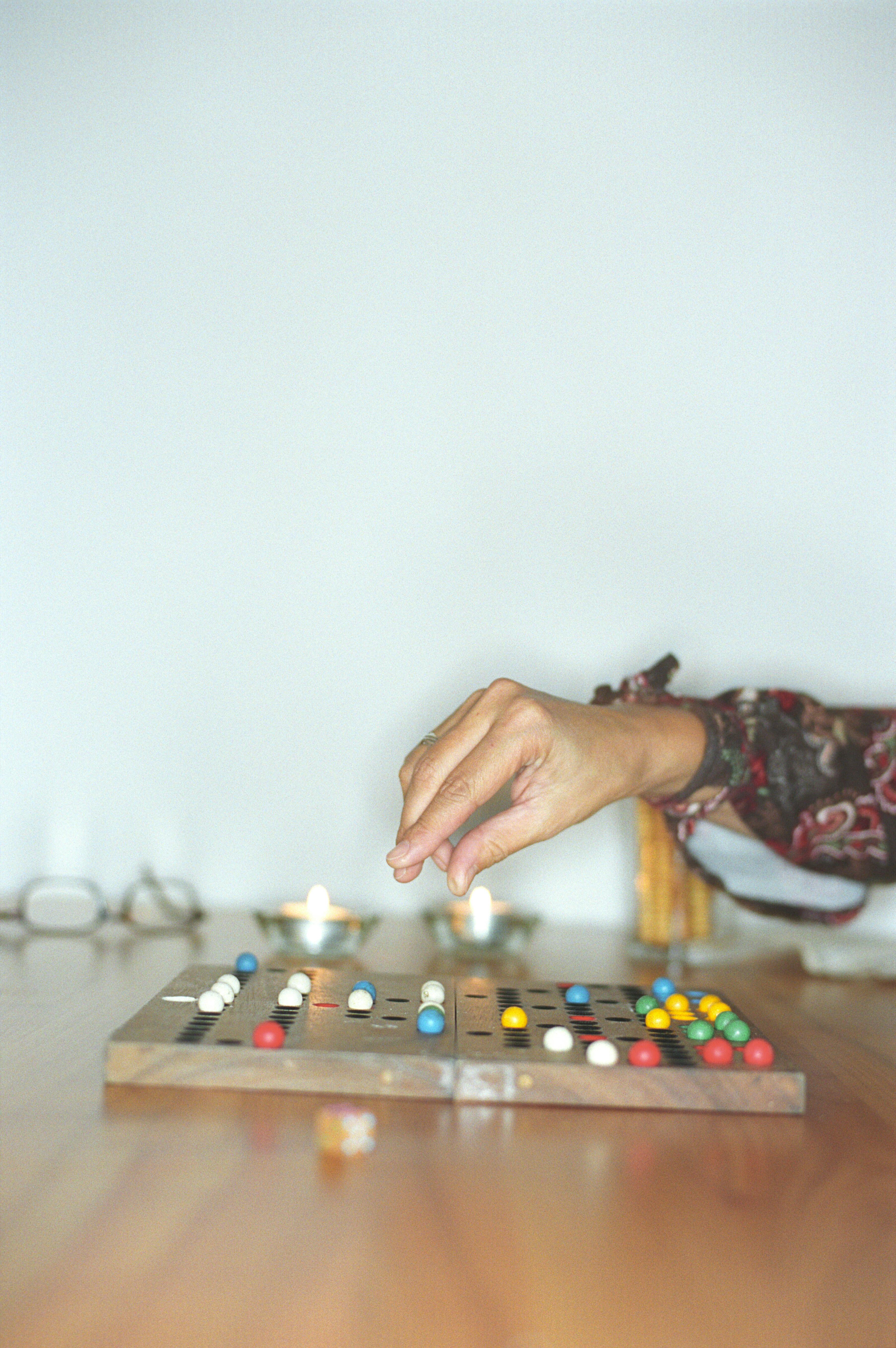 Hand of a Person Playing an Old-Fashioned Board Game · Free Stock Photo