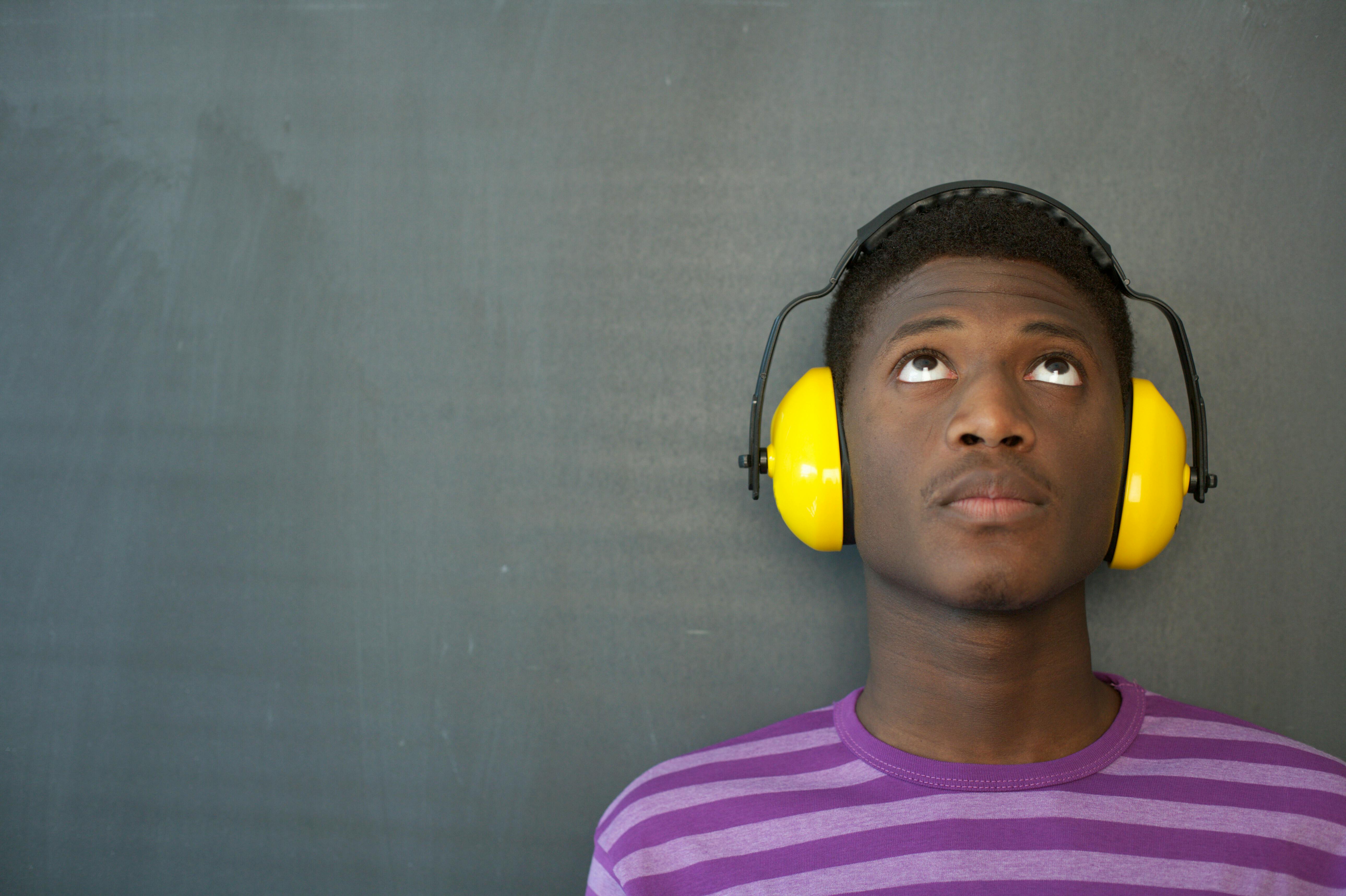 Portrait of Man Wearing Bright Yellow Headphones · Free Stock Photo