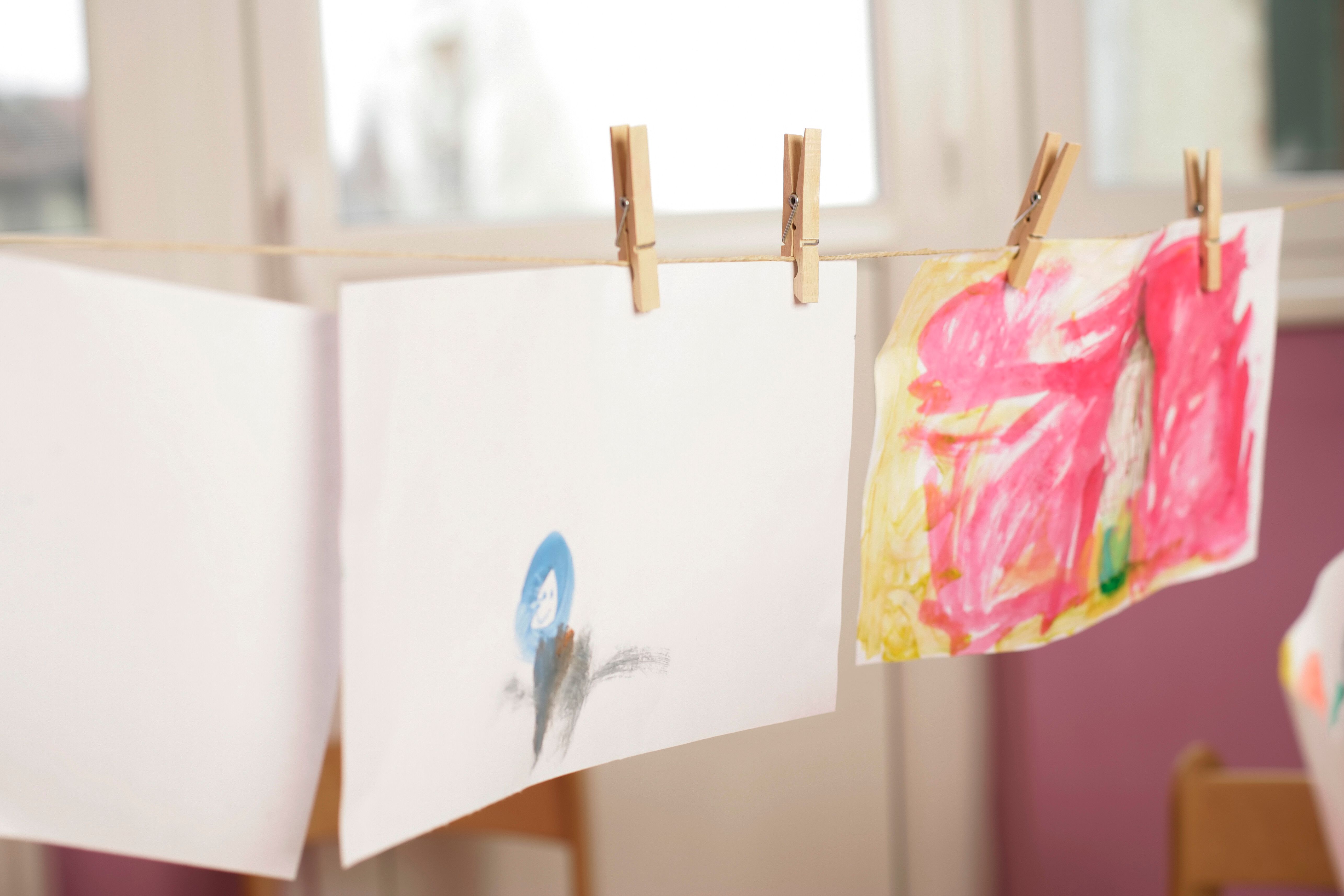 White Paper With Drawing Hanging in a Rope Line · Free Stock Photo