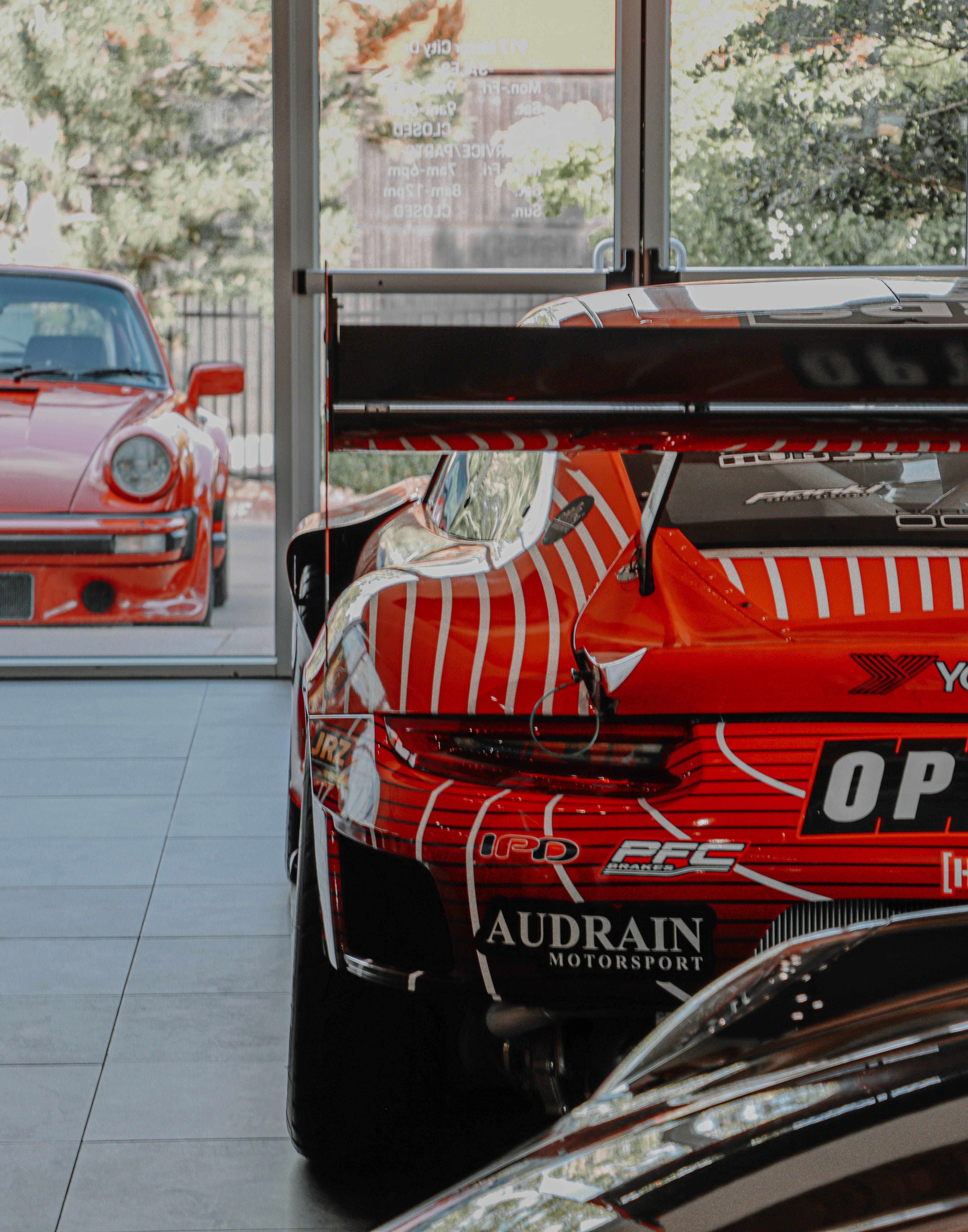 Red Racecar in Modern Indoor Garage Setting · Free Stock Photo