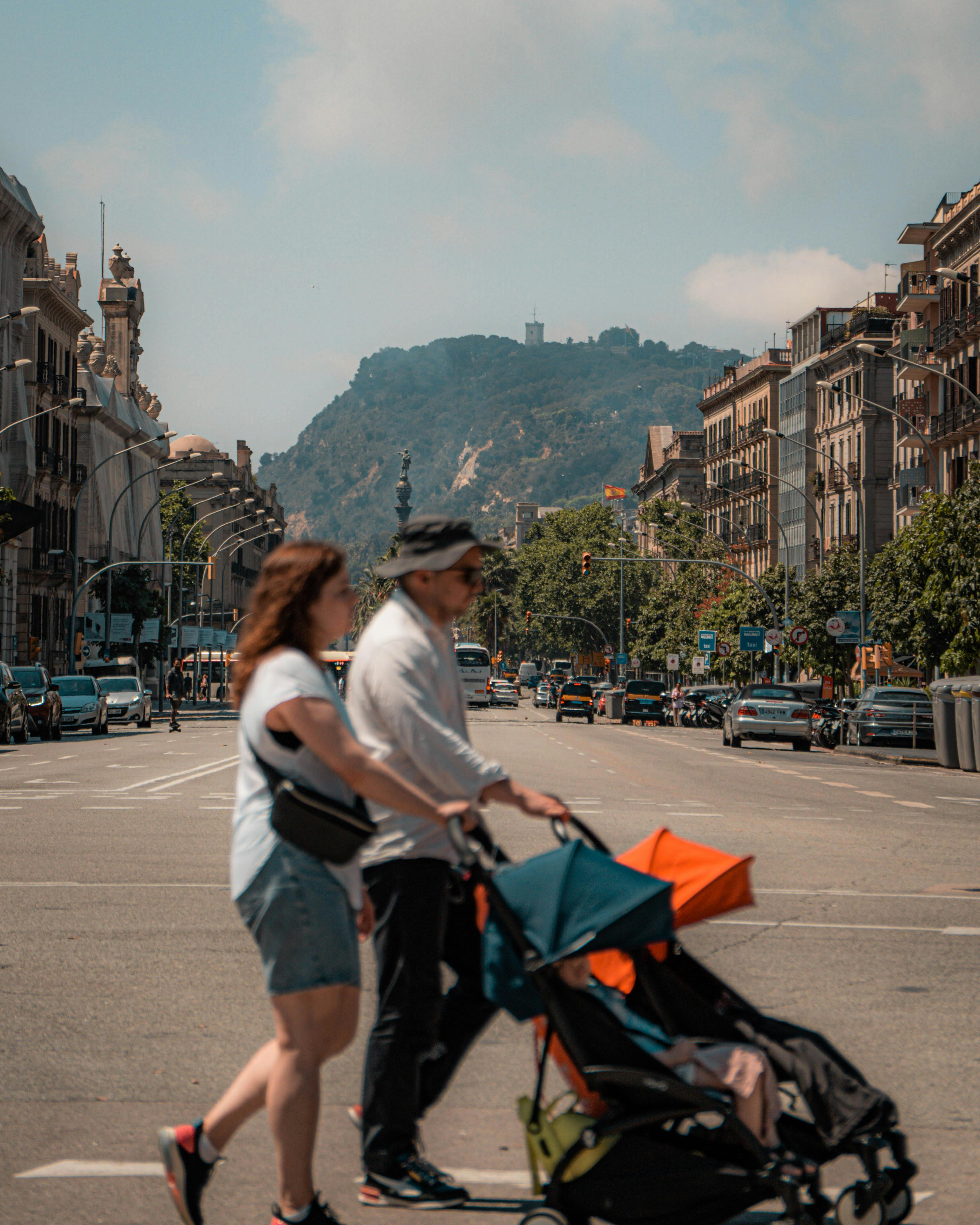 Man and Woman Pushing Baby Strollers · Free Stock Photo