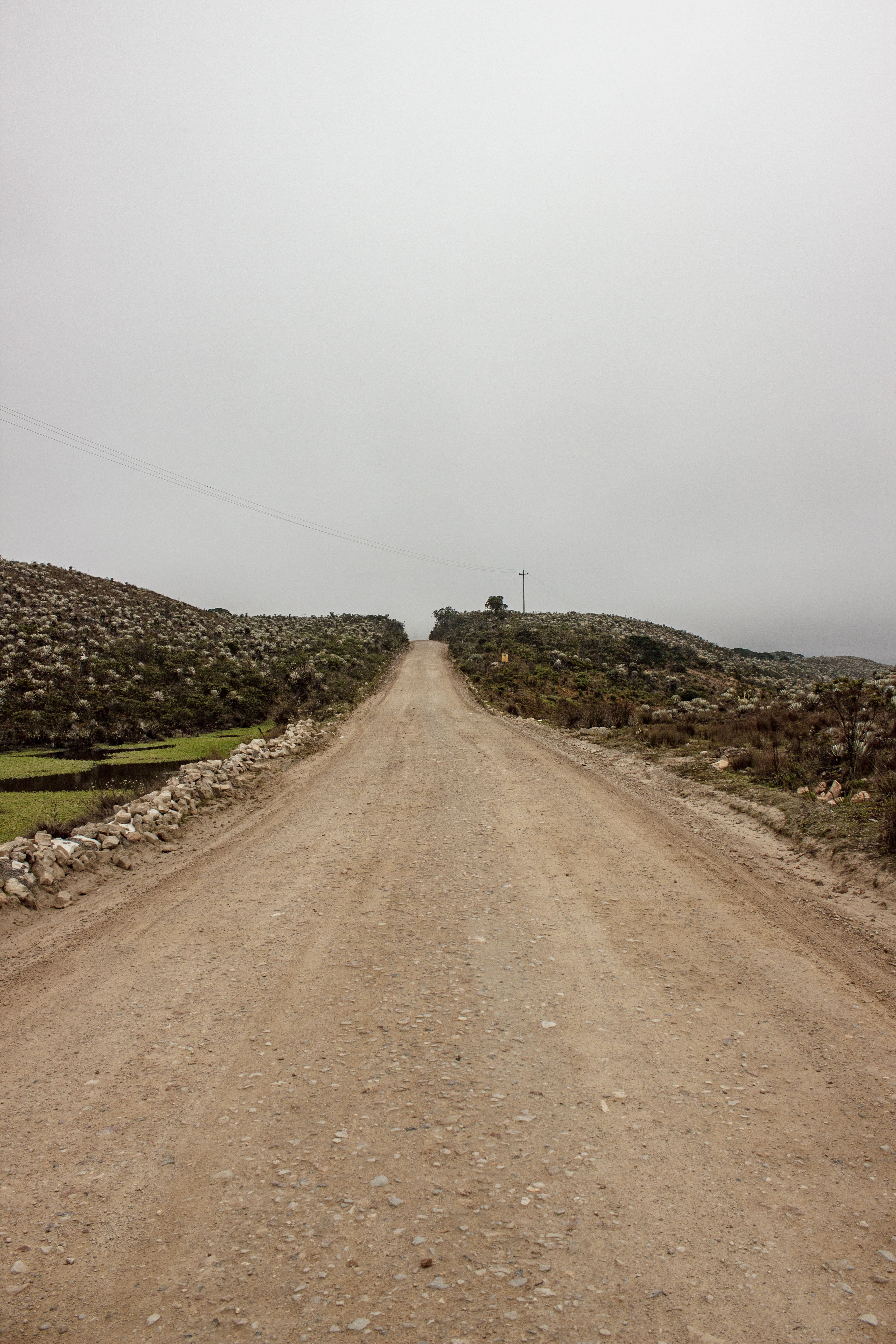 Brown Dirt Road Under White Sky · Free Stock Photo