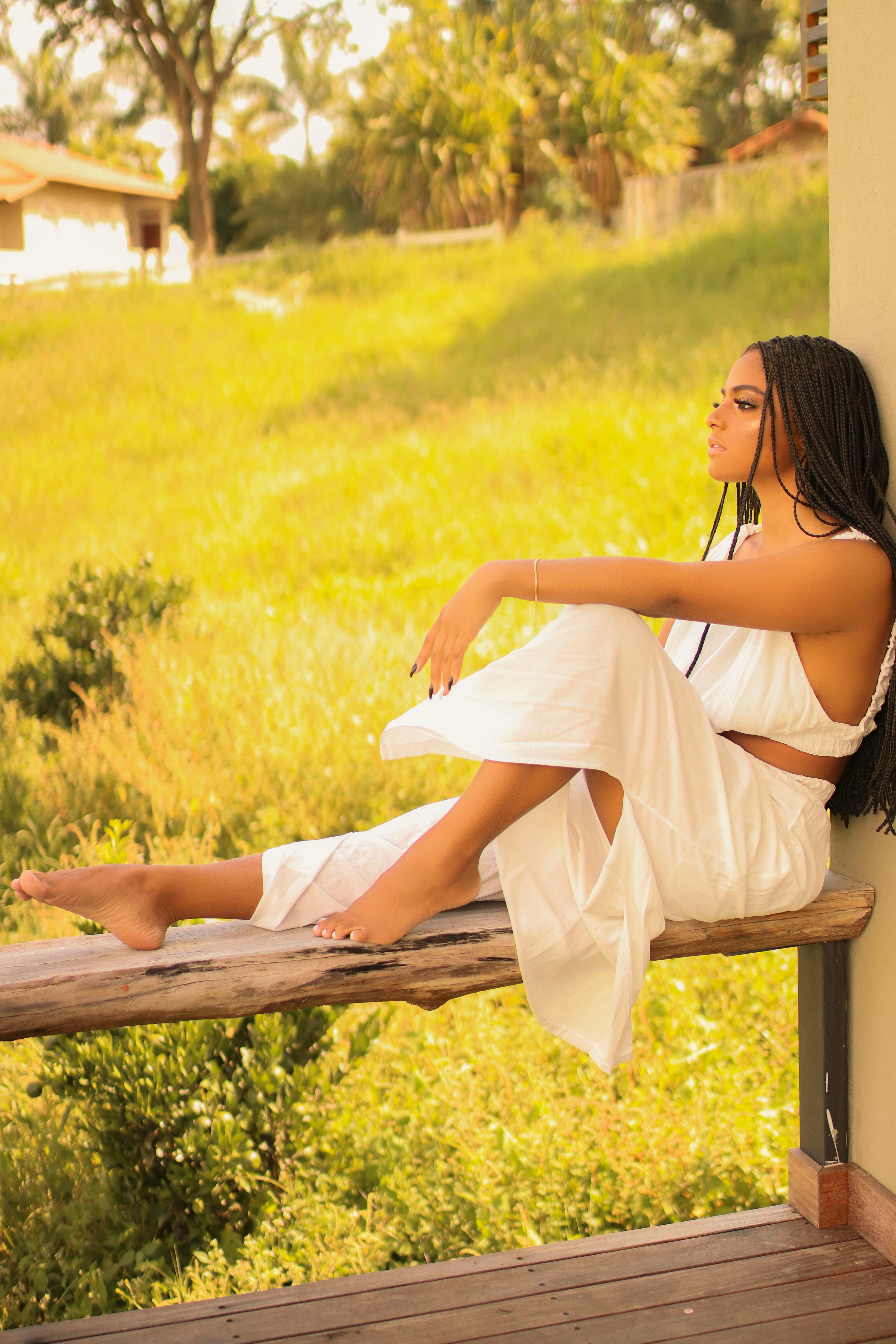 Woman in White Crop Top Sitting on Bench · Free Stock Photo