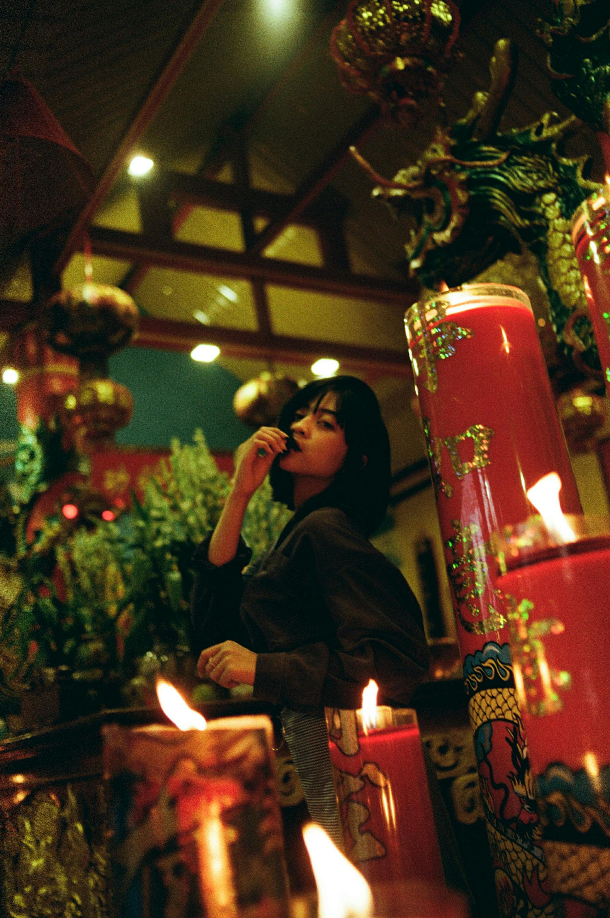 Person Lighting a Candle Using a Lighter · Free Stock Photo