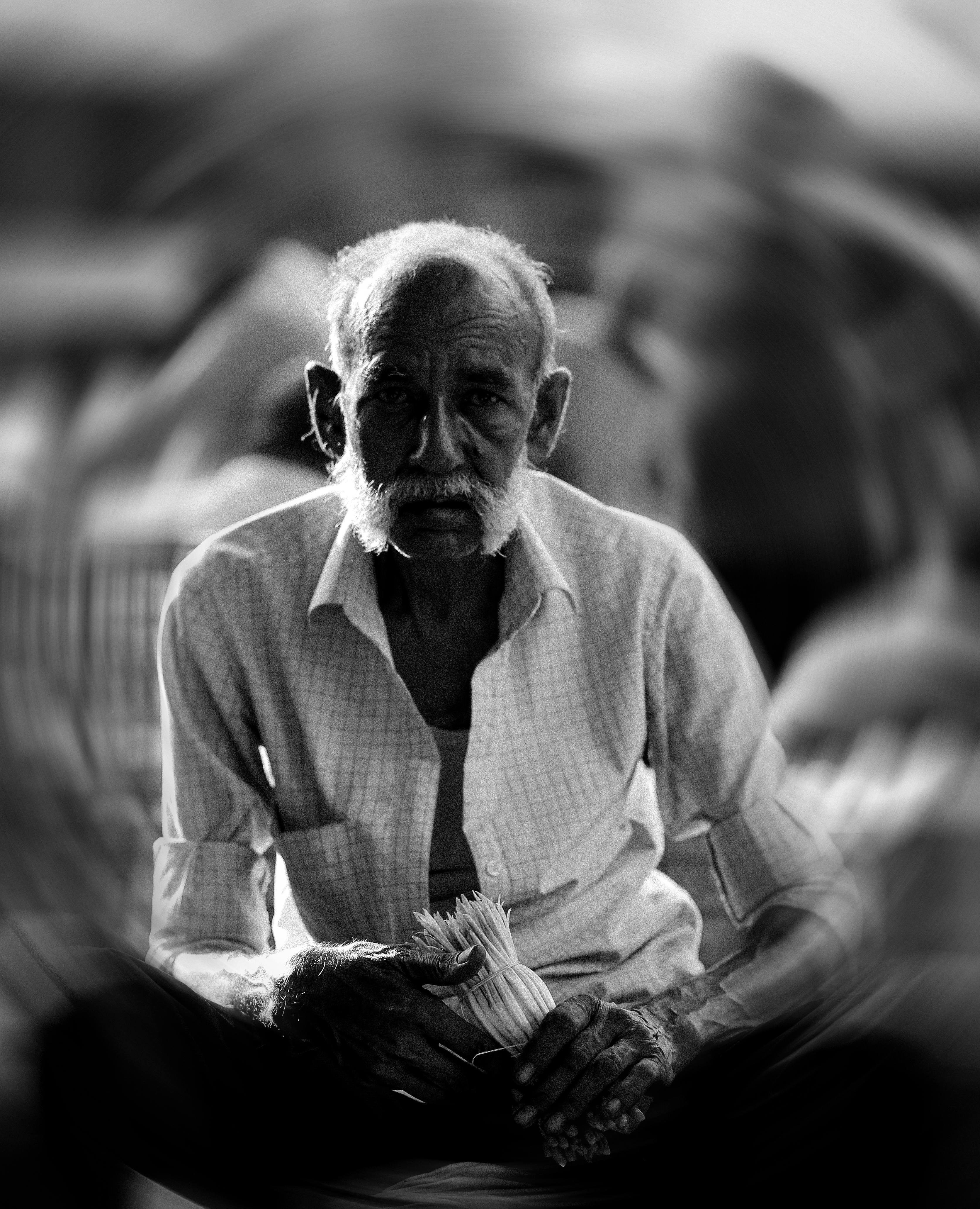 Old Man near Ornate Traditional House · Free Stock Photo