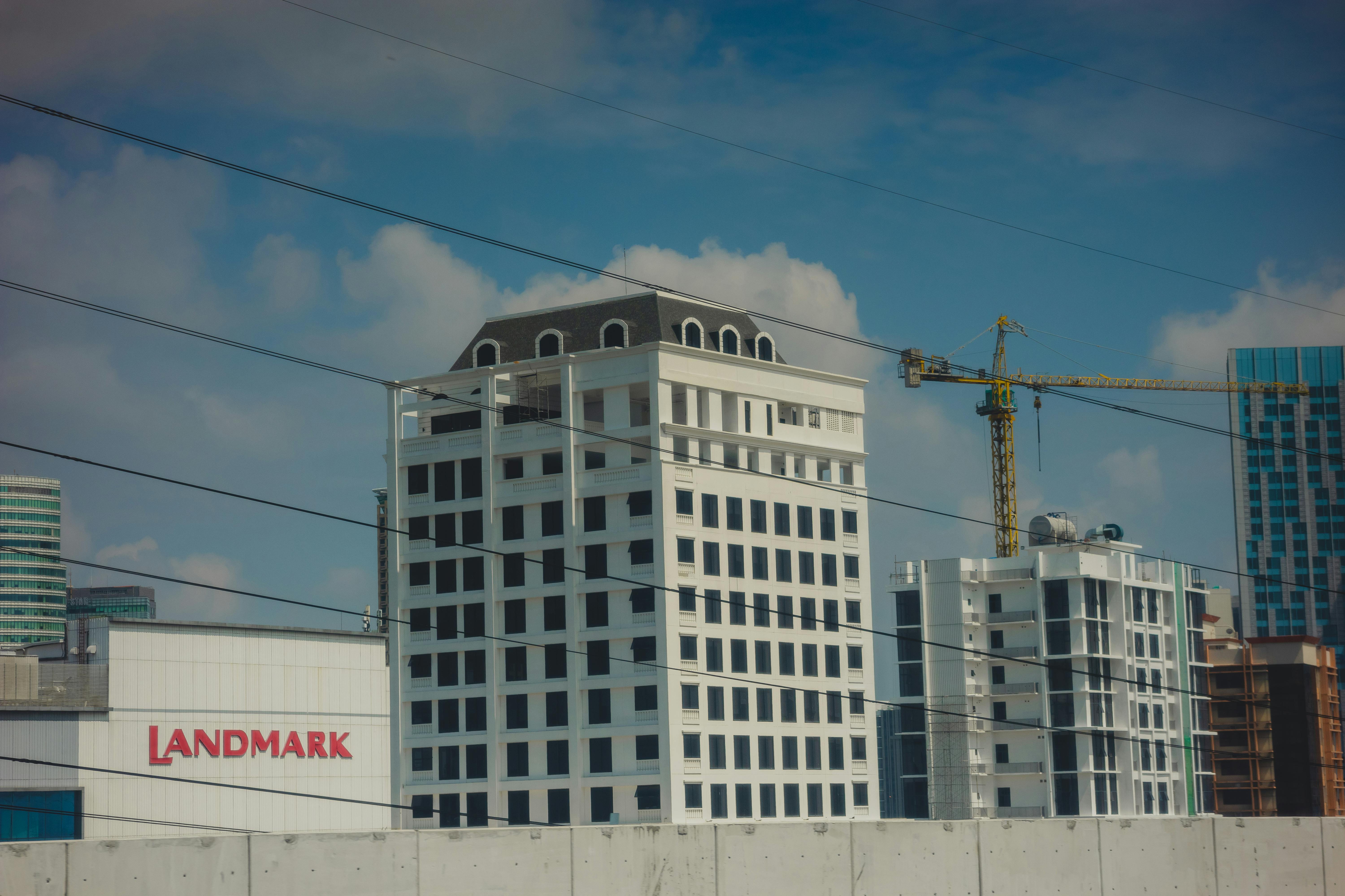 Black High Rise Building Under Cloudy Sky · Free Stock Photo
