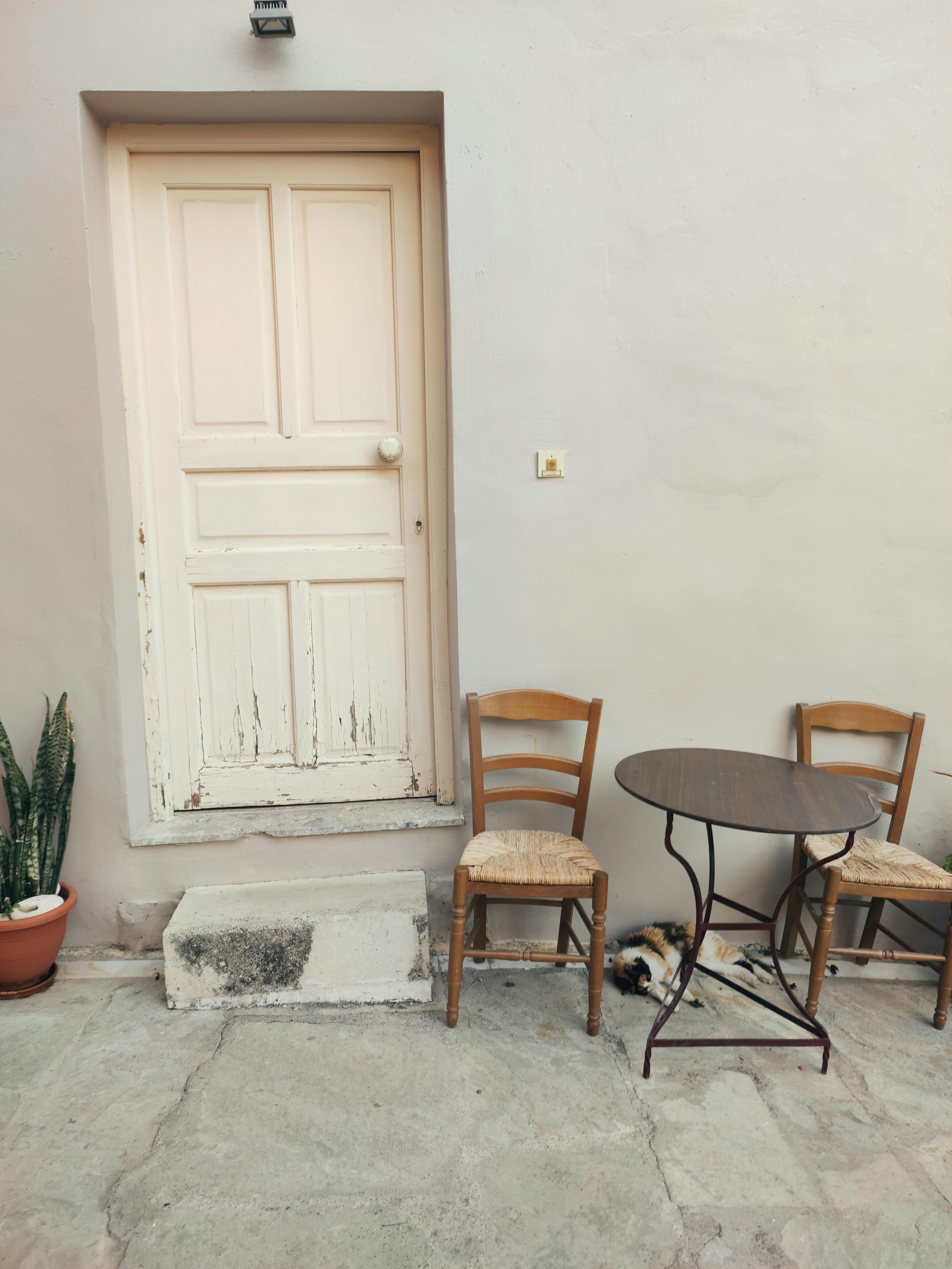 Photo of a White Door Near Chairs and a Table · Free Stock Photo