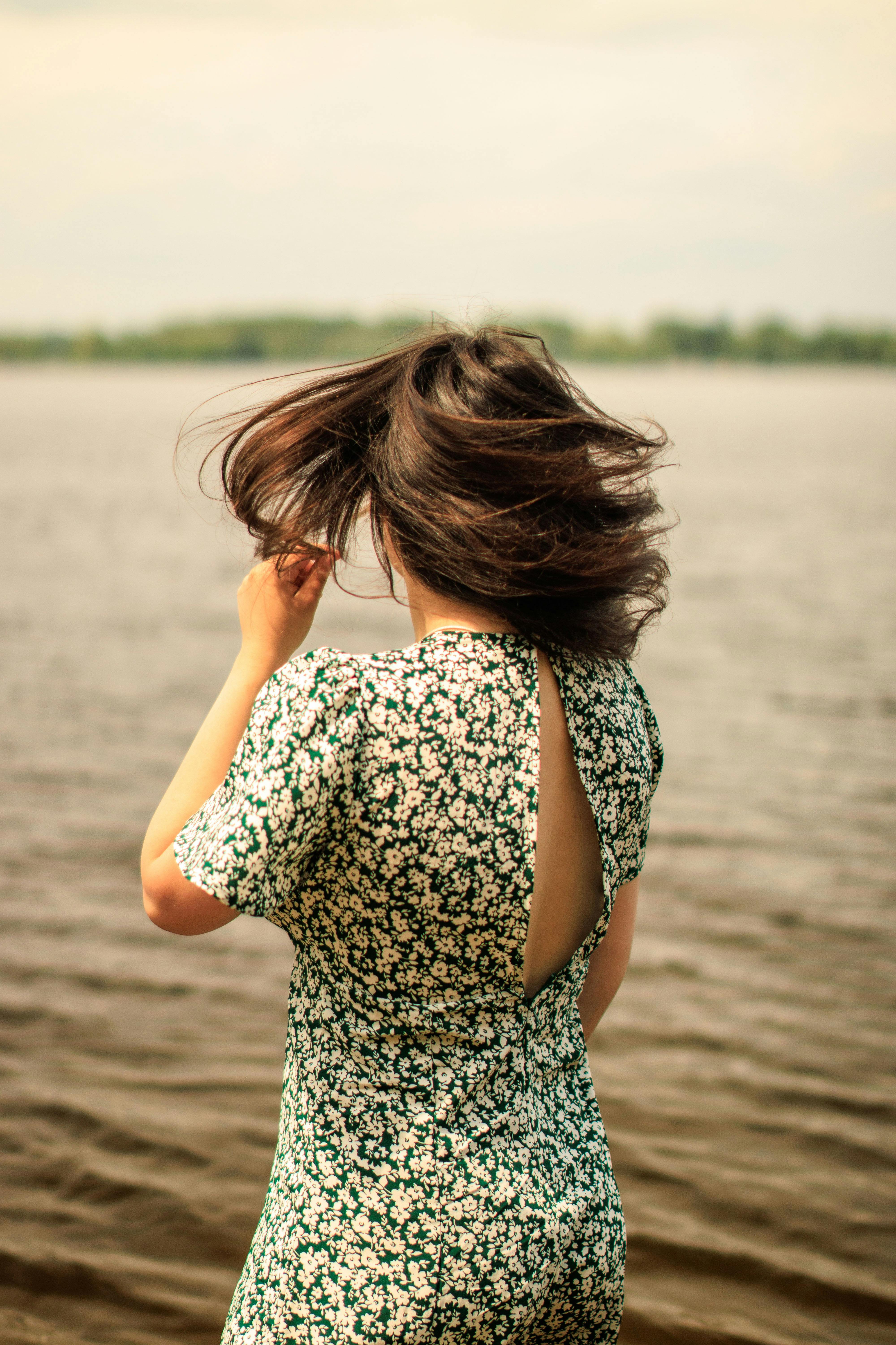Back View of a Woman Wearing a Floral Dress · Free Stock Photo