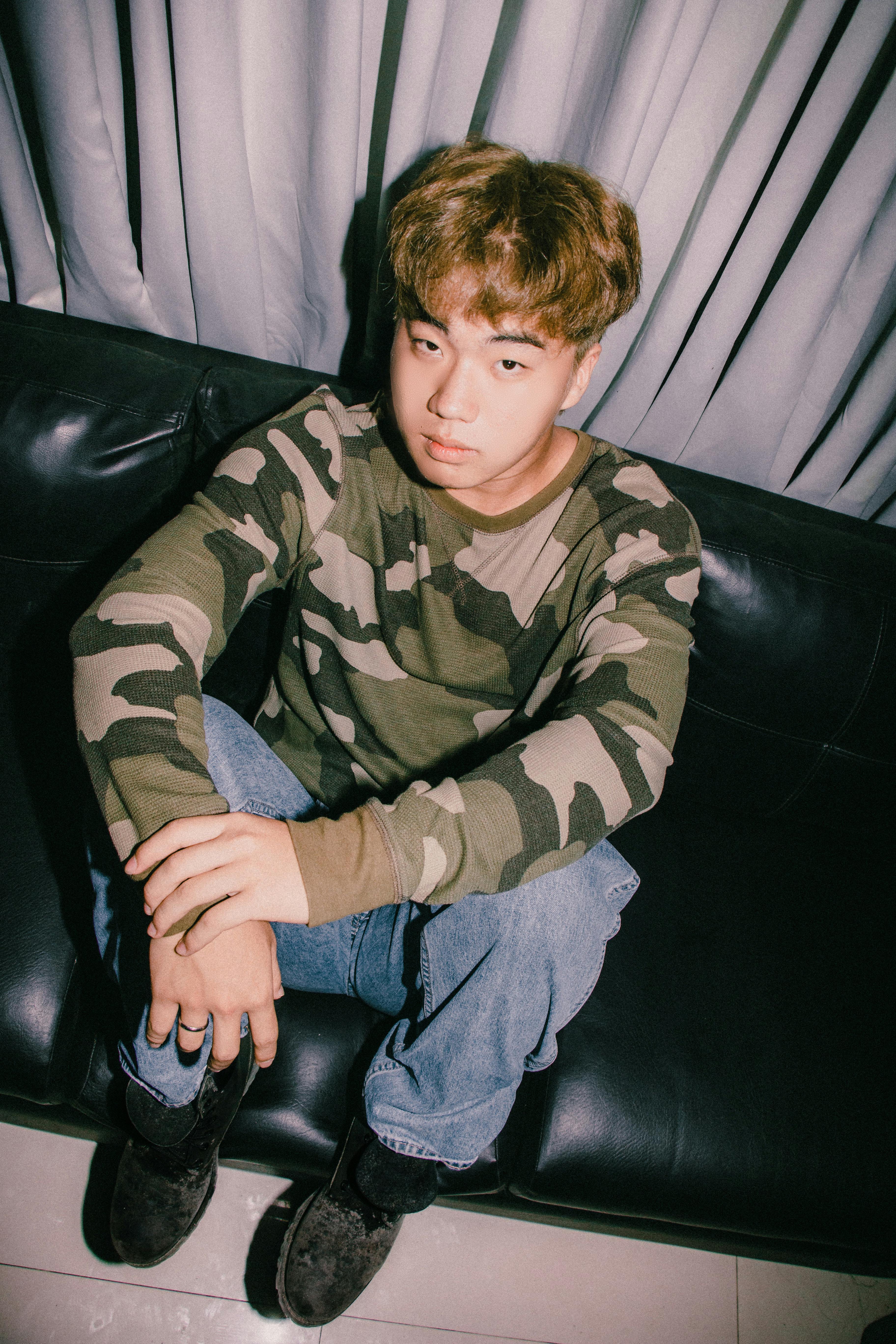 A Man in a Camouflage Long Sleeved Shirt Sitting on a Couch · Free ...