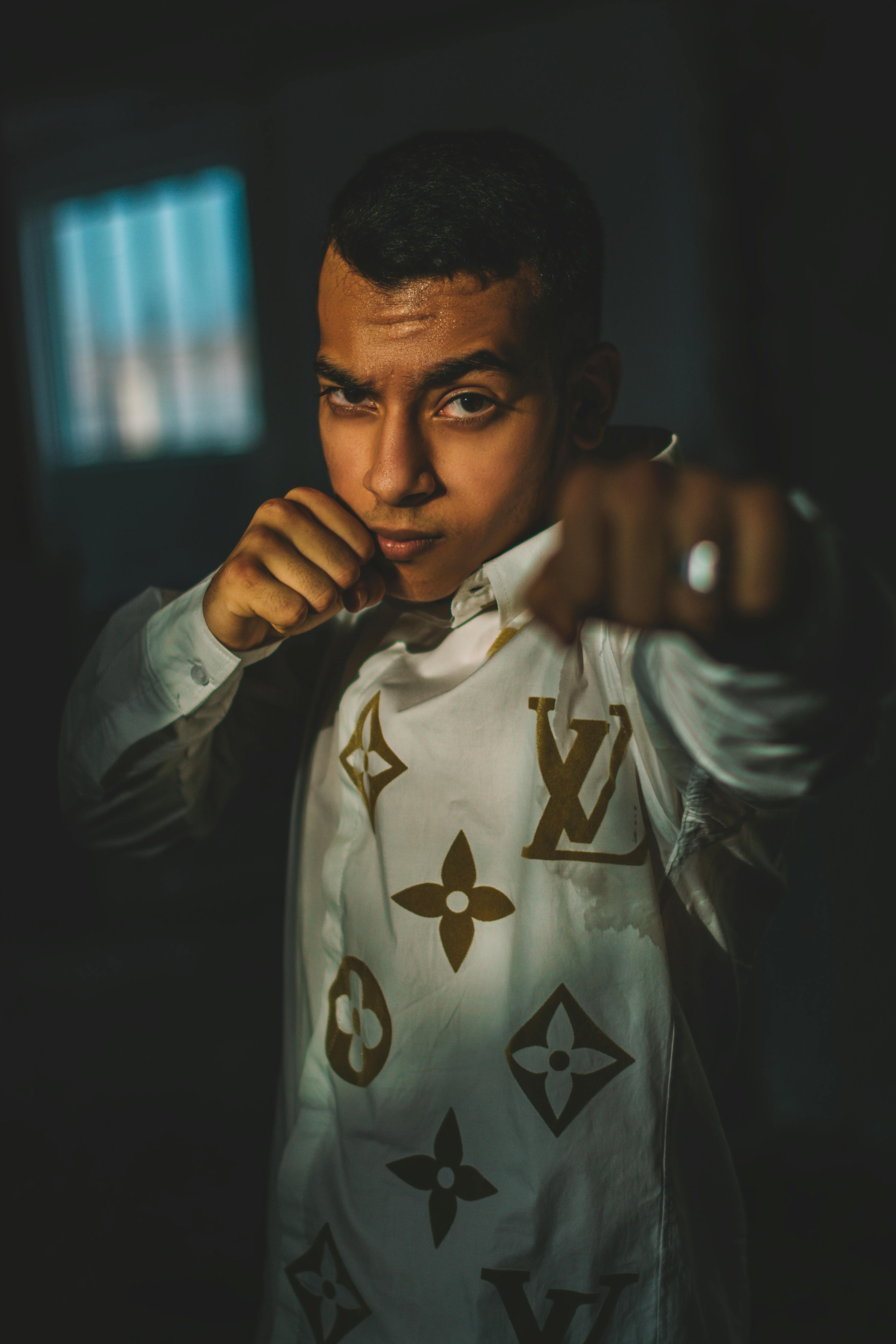 Man in White Long Sleeve Shirt Throwing Punch · Free Stock Photo