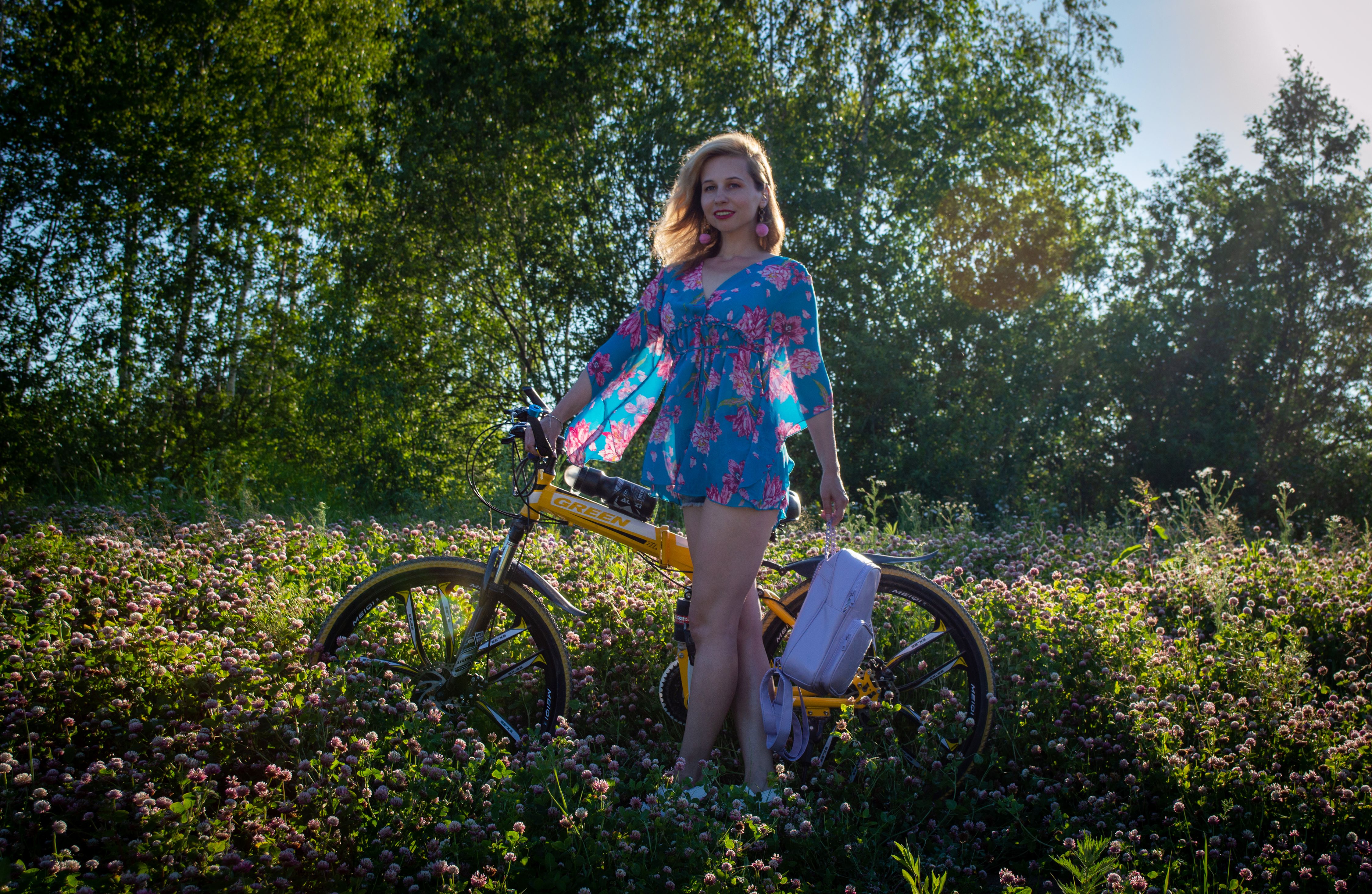 A Woman in a Romper Holding on Her Bicycle · Free Stock Photo