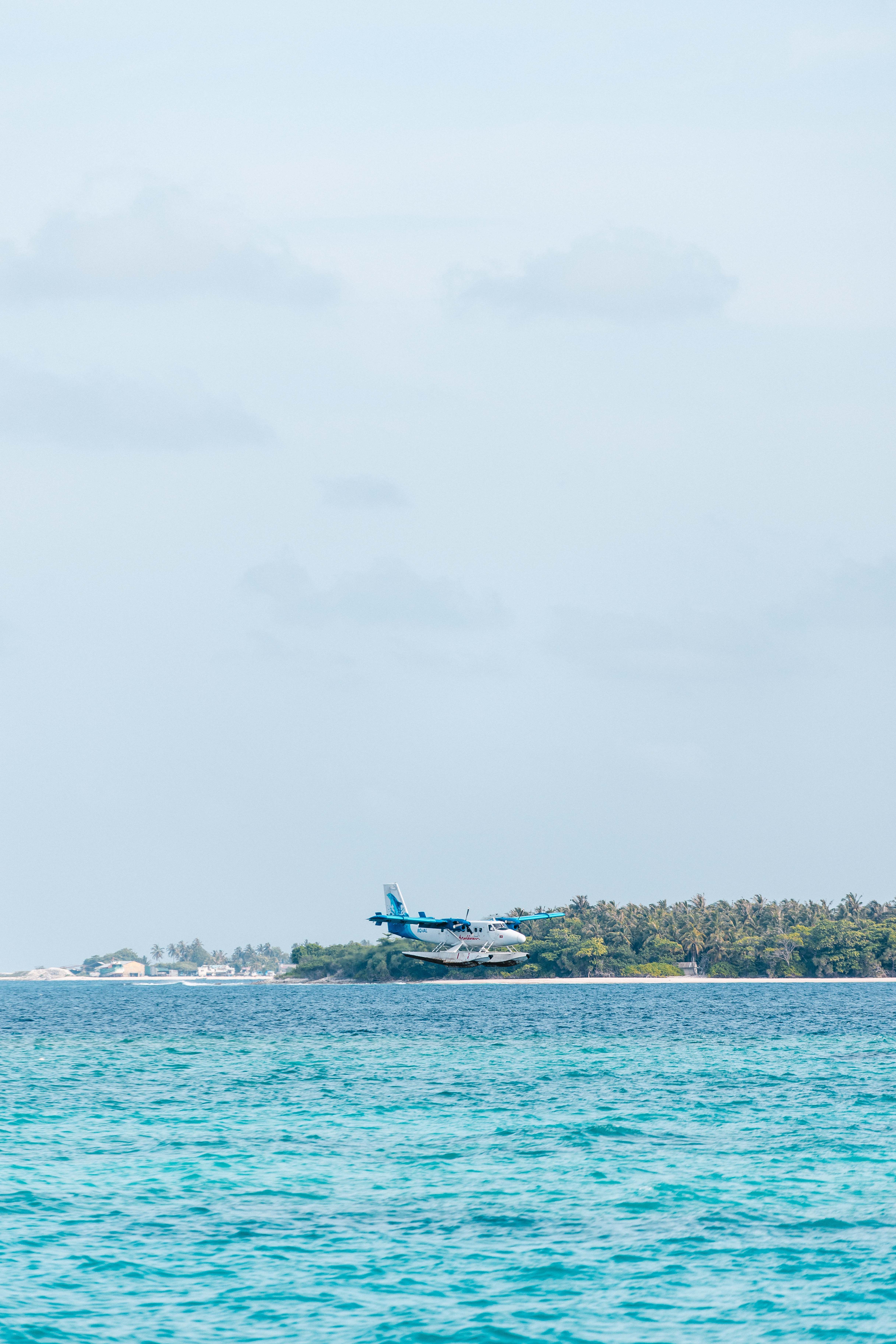 Airplane Flying Over the Sea · Free Stock Photo