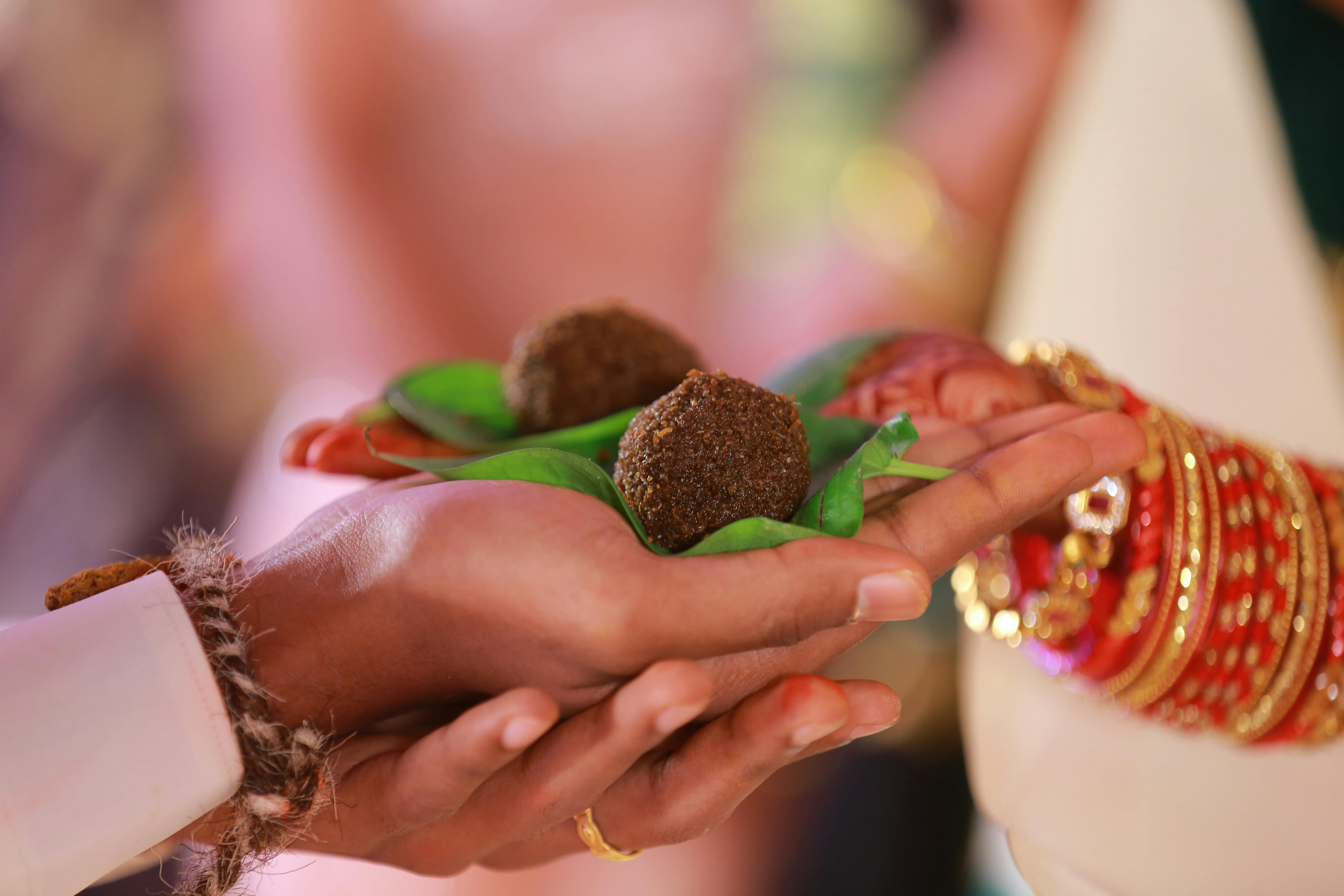 Women Holding Traditional Food in Their Hands · Free Stock Photo