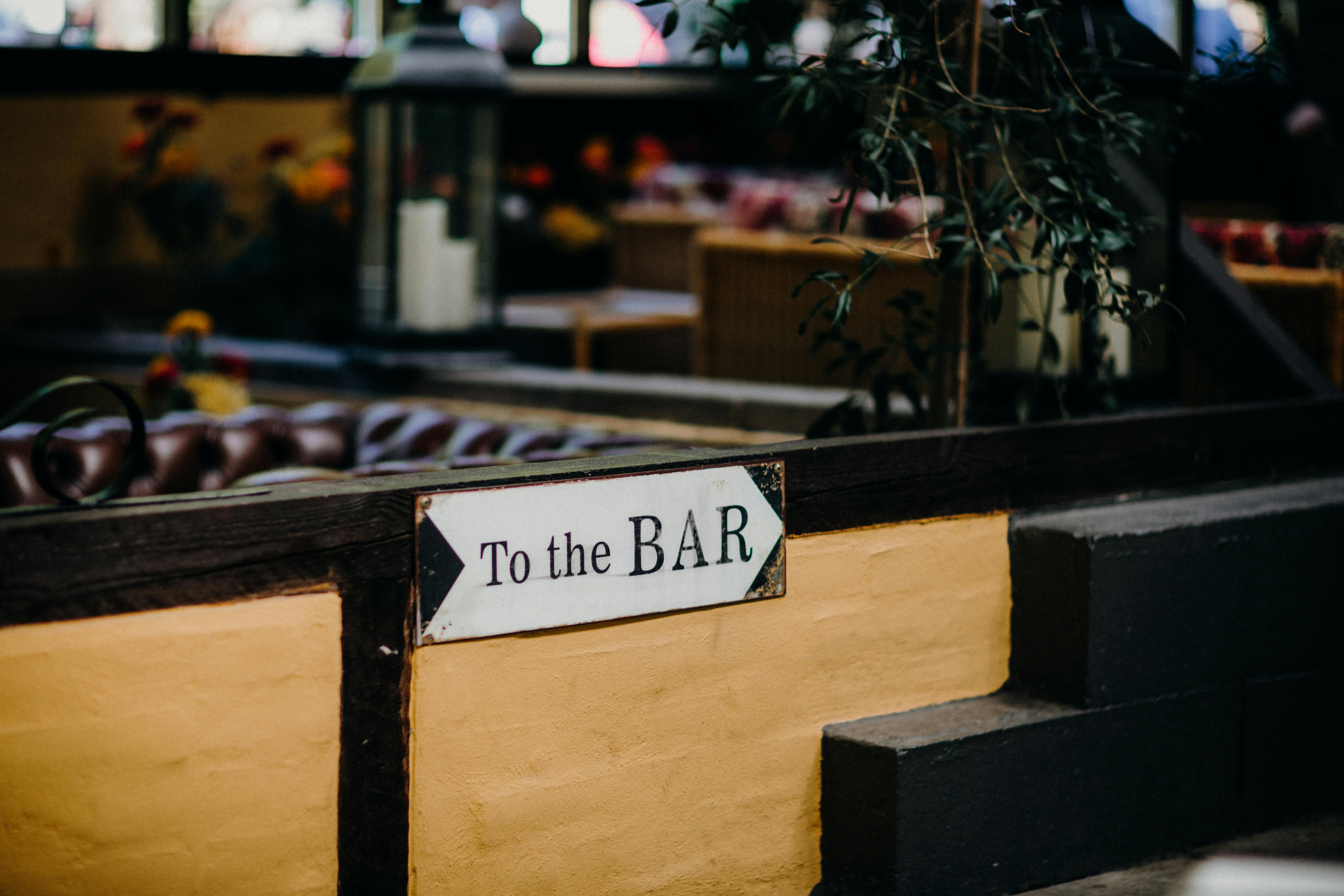 Photo of a Direction Signage to the Bar · Free Stock Photo