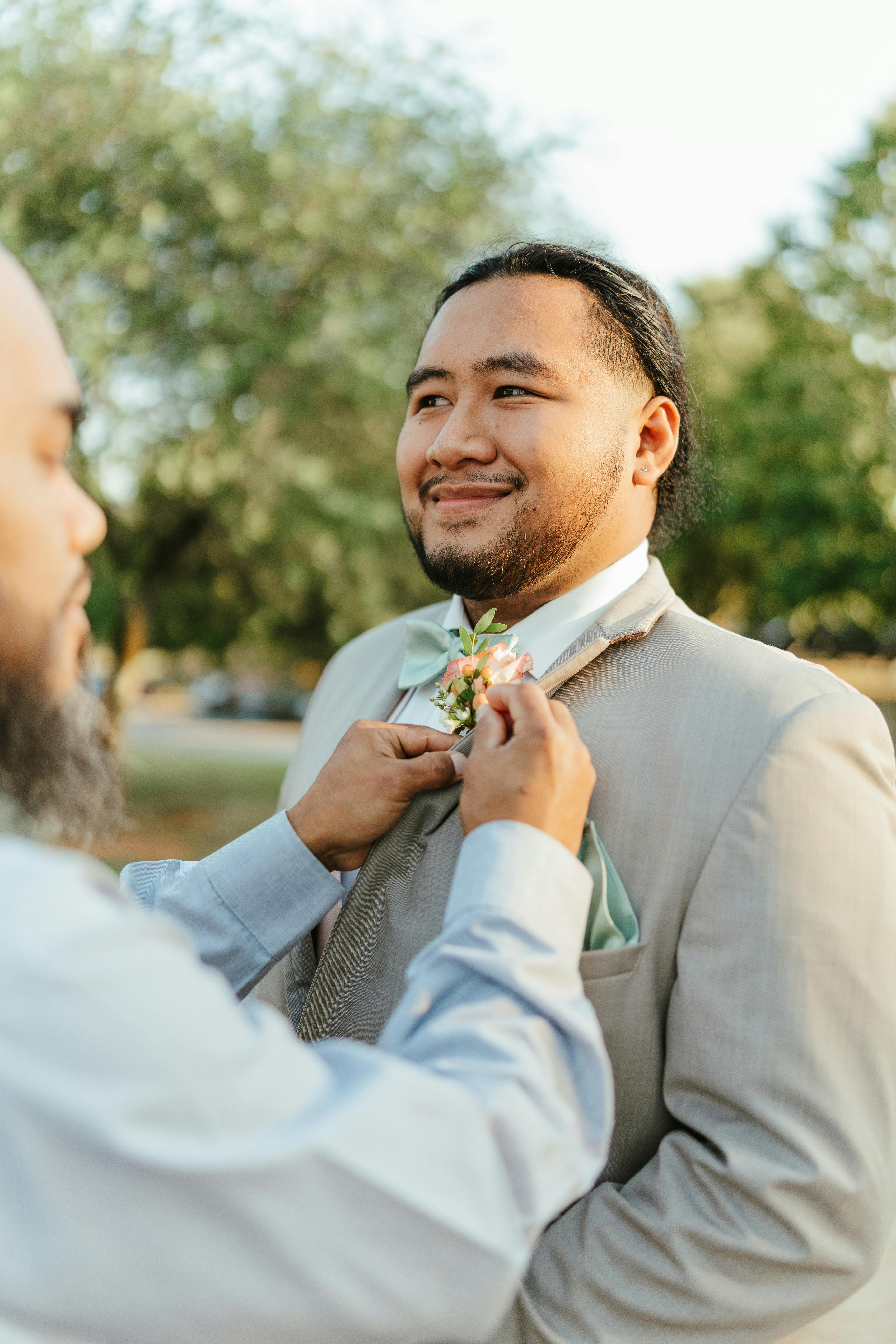 A Smiling Man Putting On Suit Photos, Download The BEST Free A Smiling ...